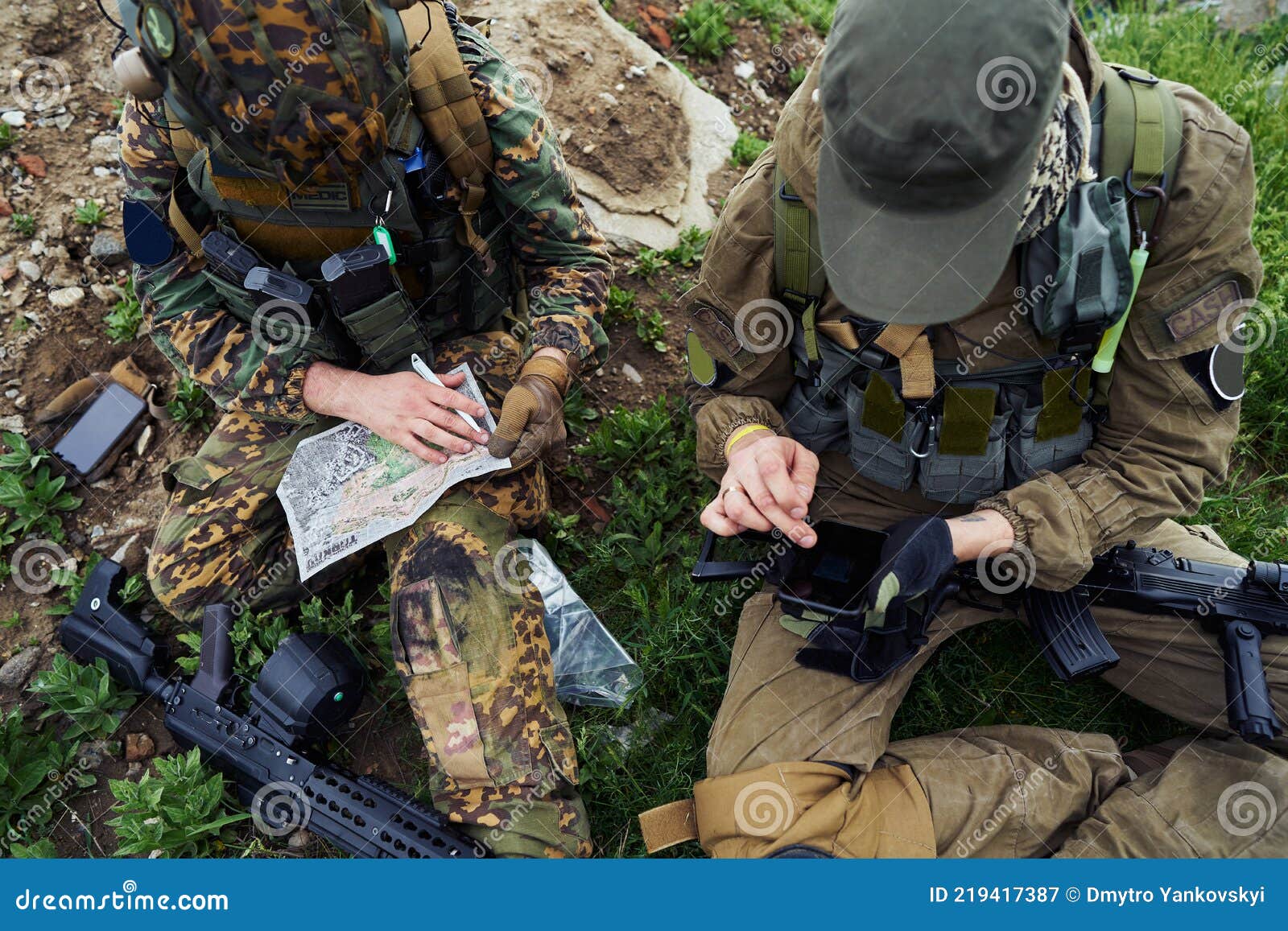 Airsoft Players Sit on the Ground and Examine the Map Stock Image ...