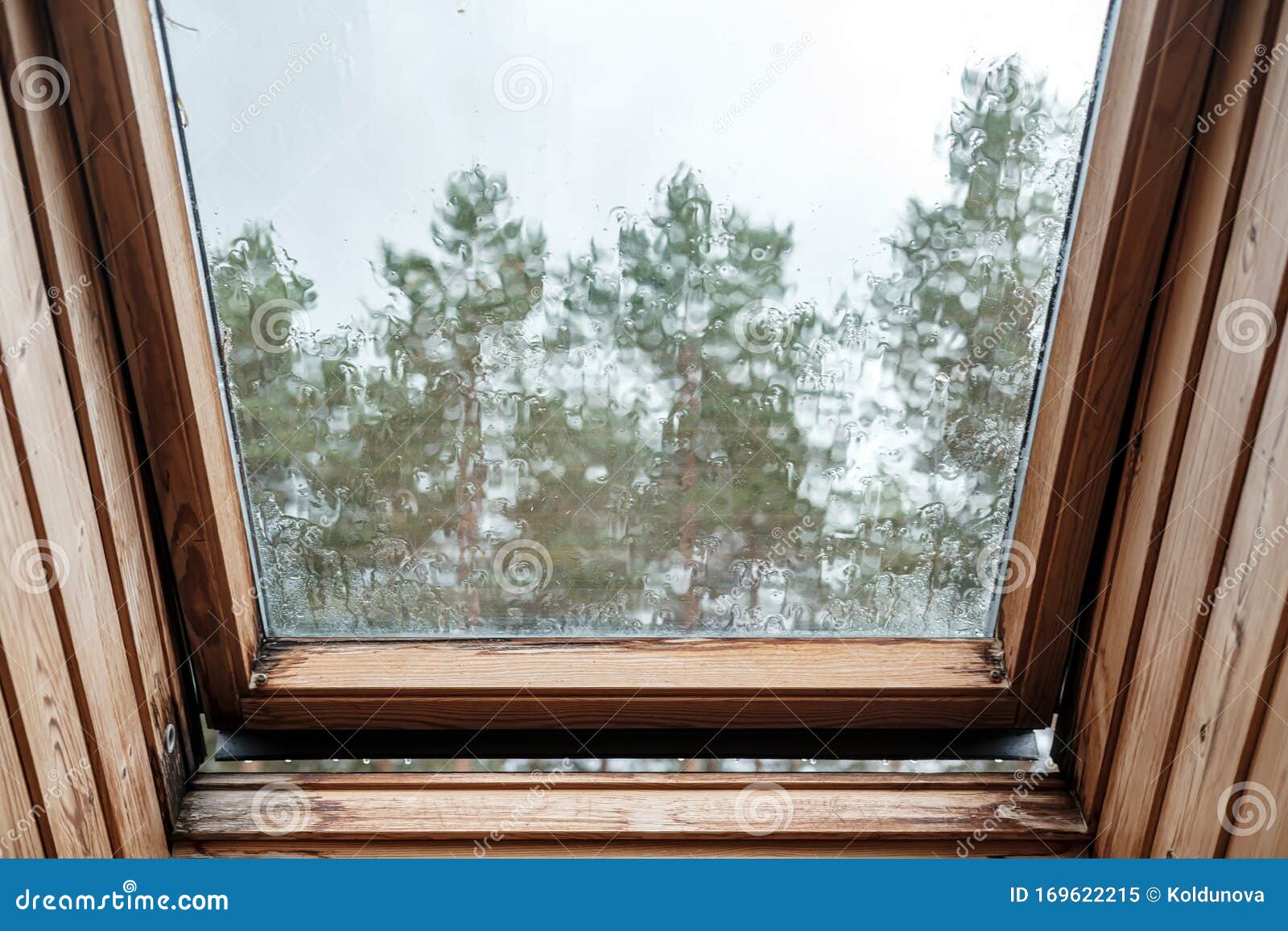 An Ajar Roof Window in the Attic, with Raindrops Dripping Down the ...