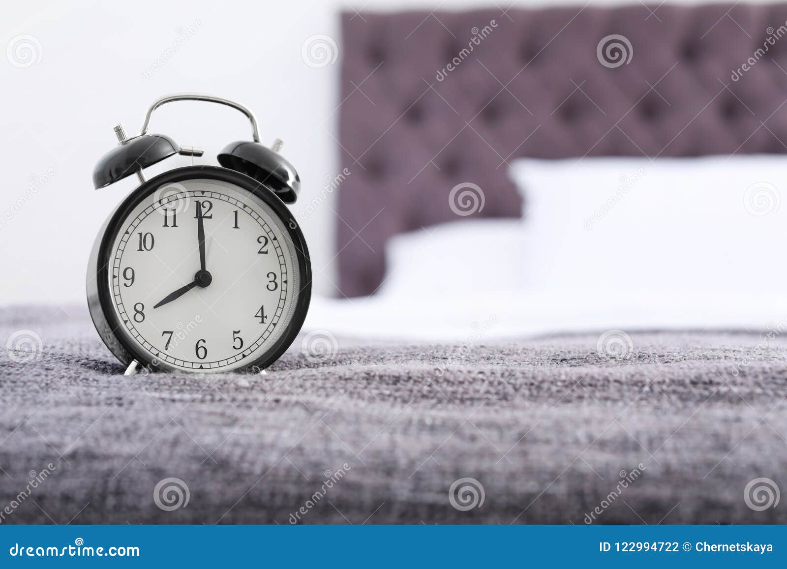 Alarm clock on bed stock photo. Image of interior, bedtime - 122994722