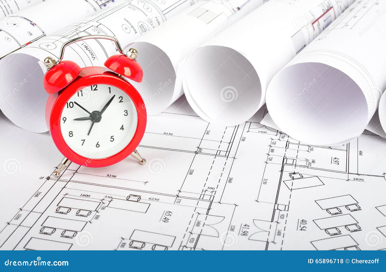 Alarm clock on blueprints stock photo. Image of clock - 65896718