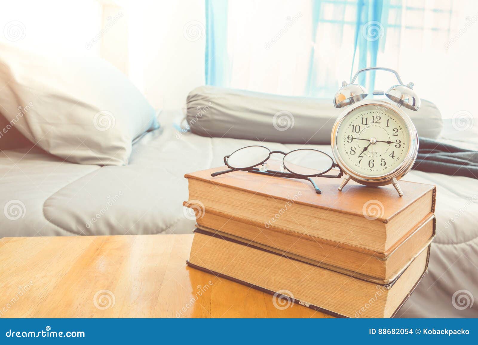 Alarm clock with book stock photo. Image of bell, early - 88682054