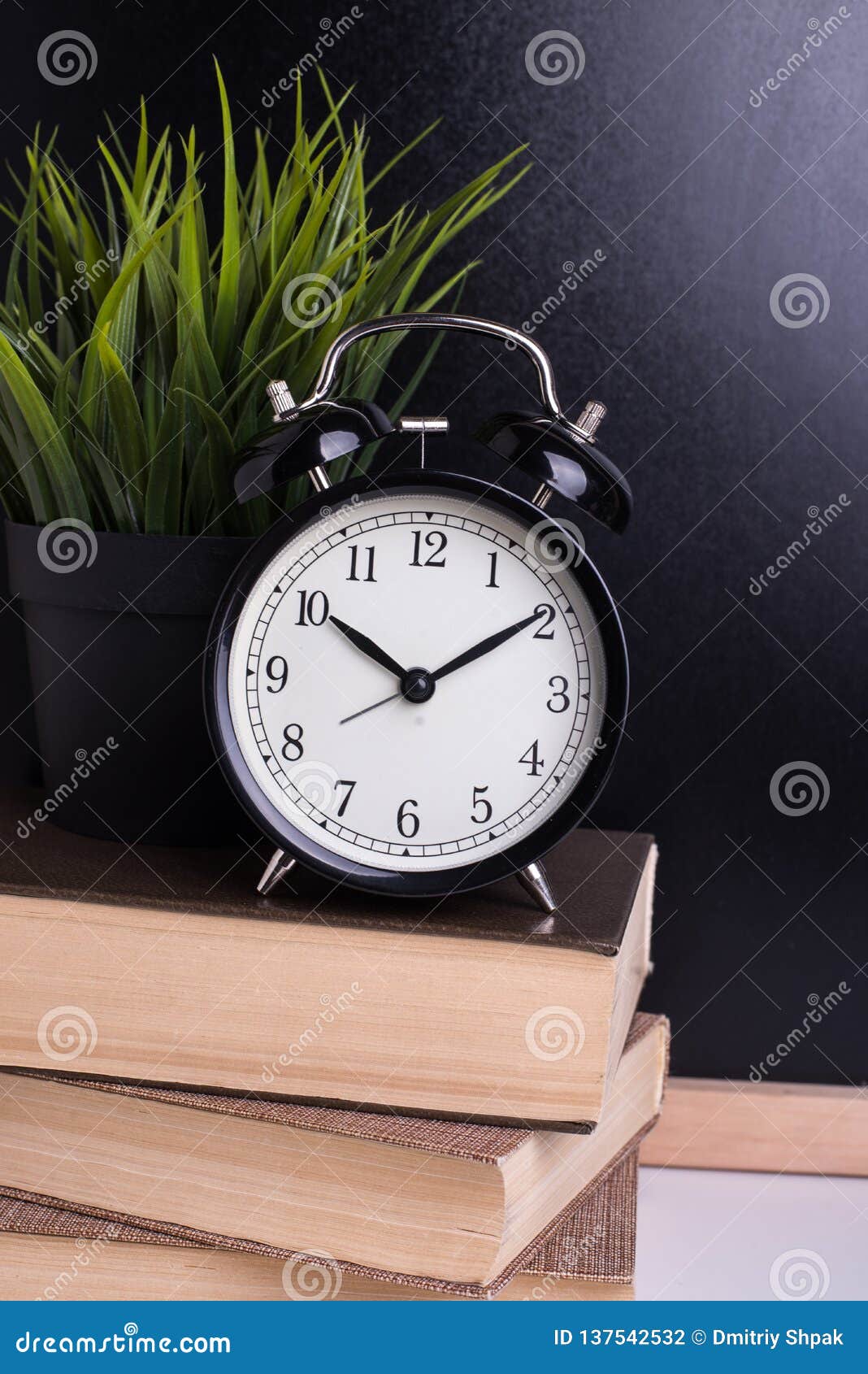 Alarm clock is on books stock photo. Image of bedroom - 137542532