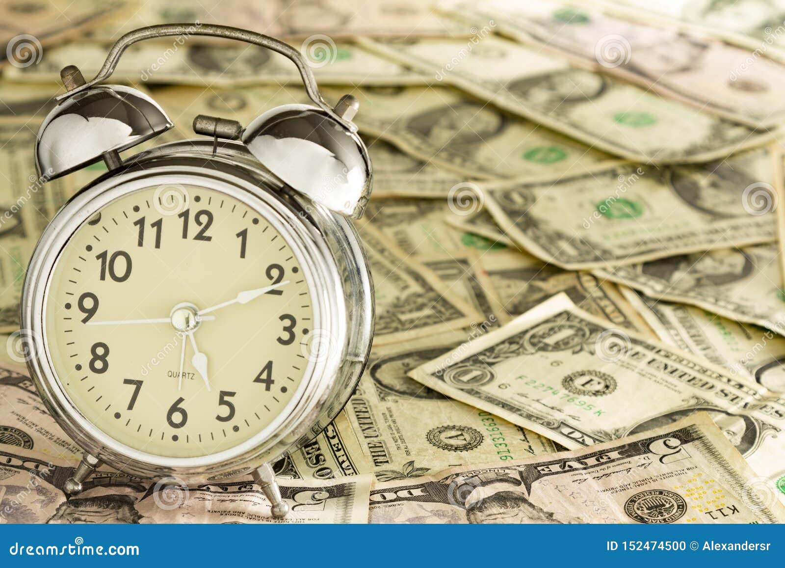 Alarm Clock on Carpet of Dollar Bills, Time is Money Stock Photo ...