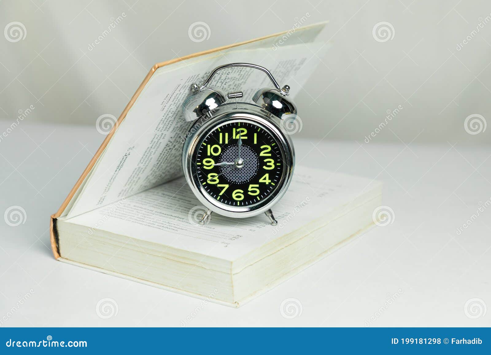 Alarm Clock on Half Open Book Isolated Stock Photo - Image of learn ...