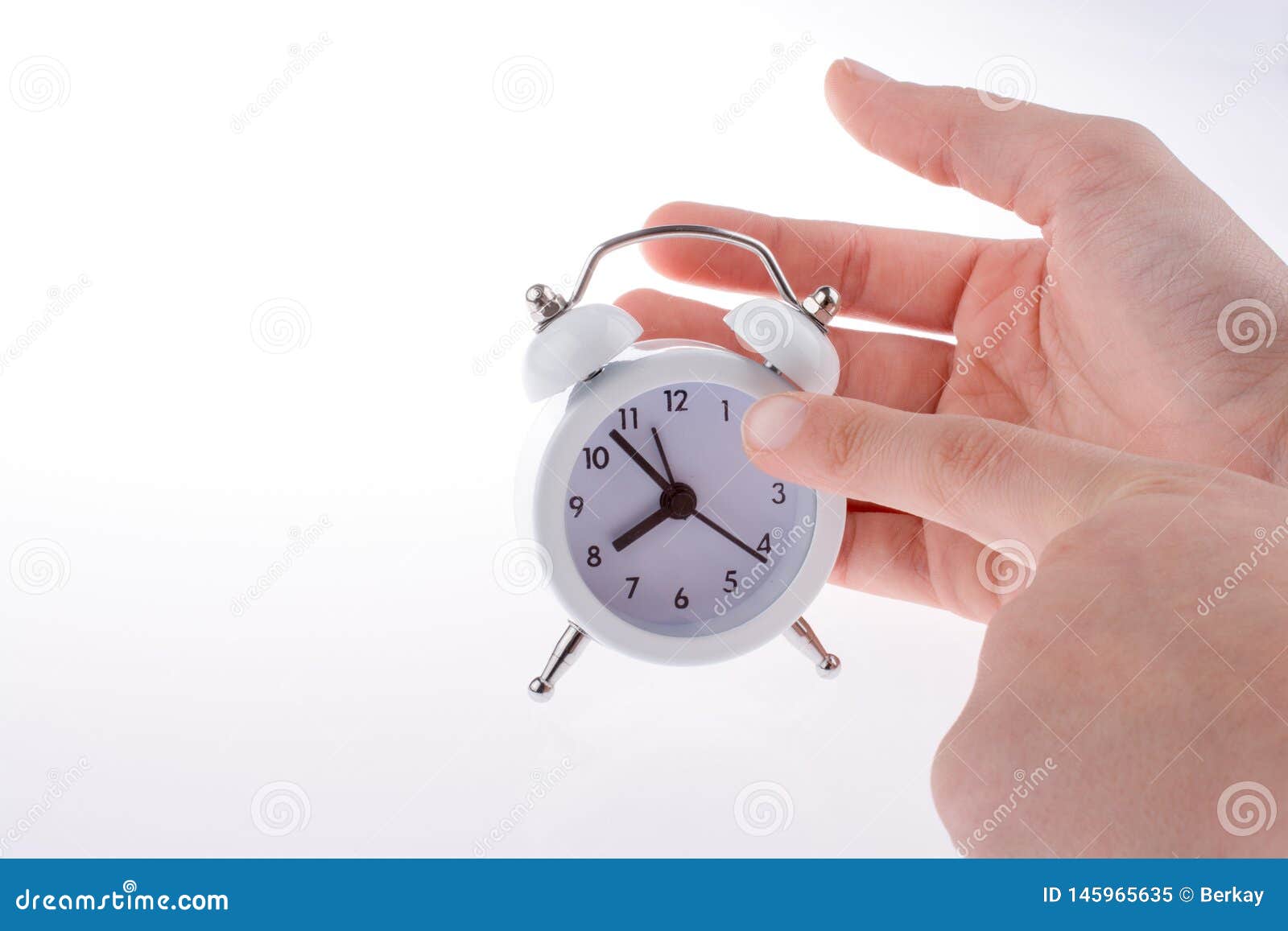 Alarm clock in hand stock image. Image of alarm, clockwise - 145965635
