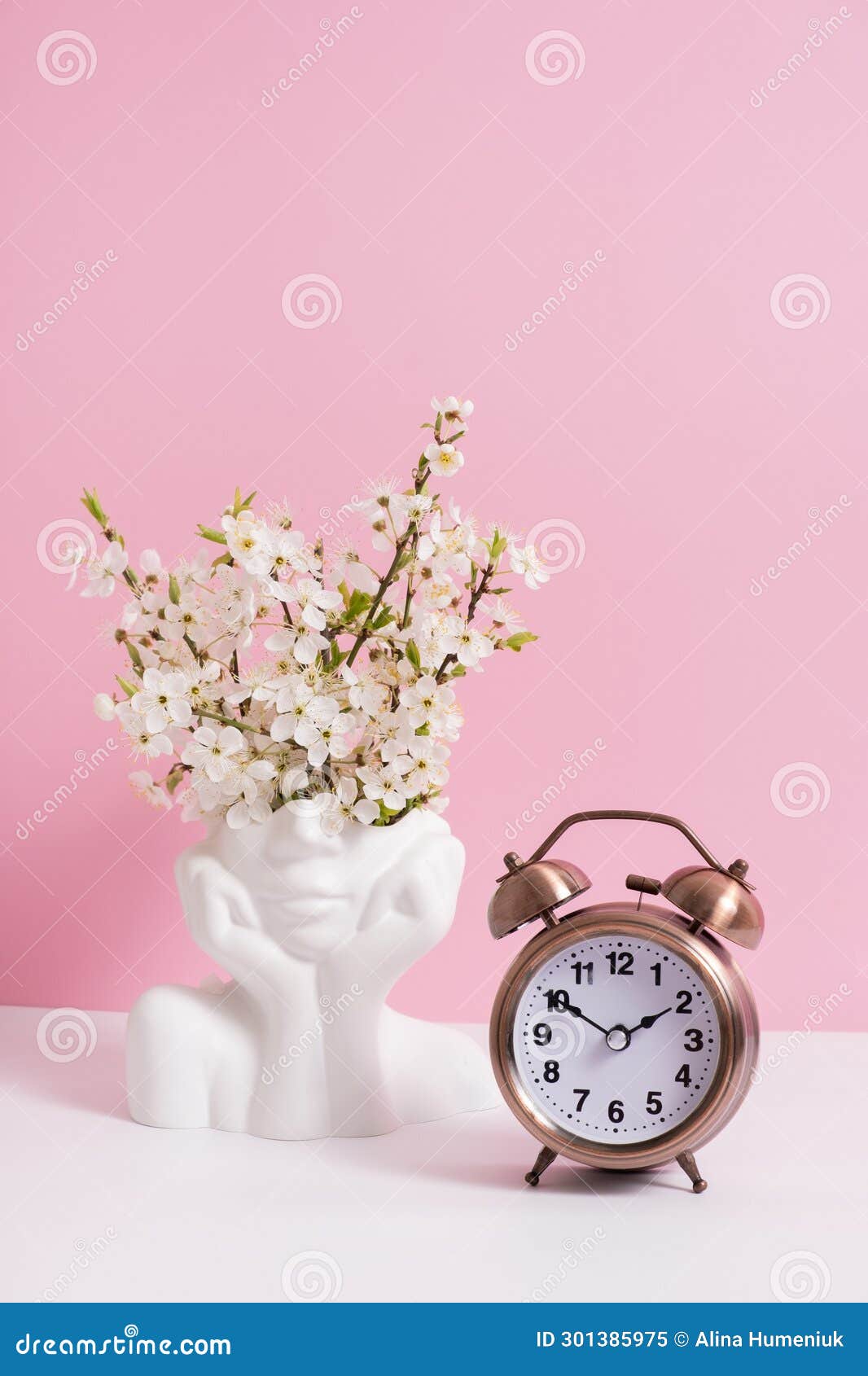 Alarm Clock and Head Shape Vase with Spring Bloom Flowers on Pink ...