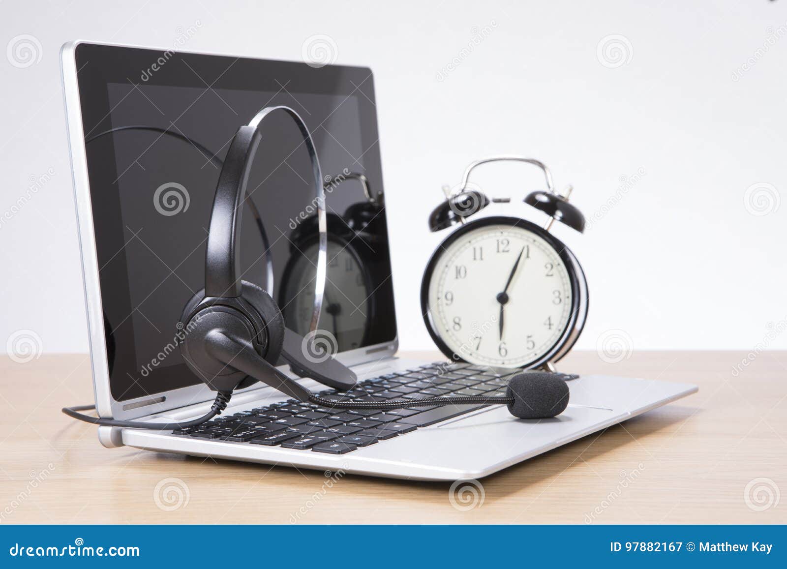 Alarm Clock and Headset on Laptop Keyboard Stock Image - Image of ...