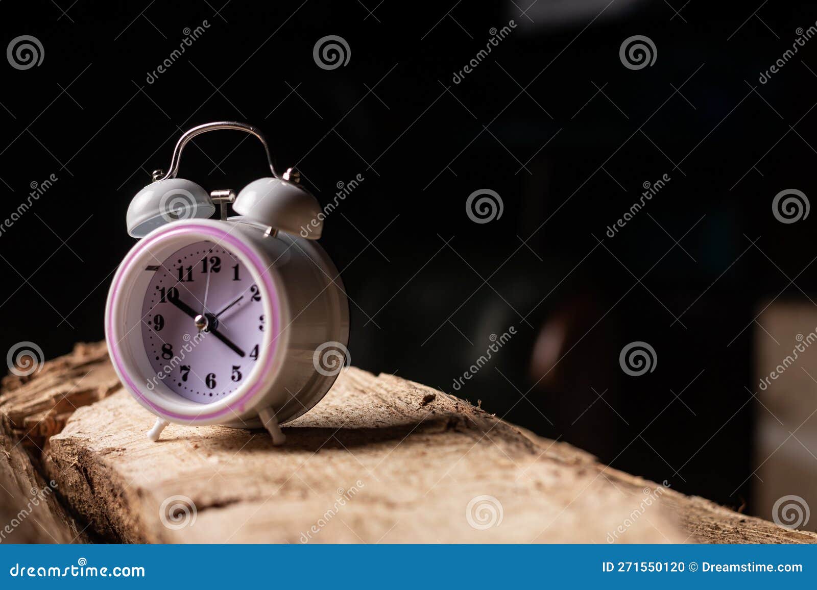Alarm Clock on Log on Dark Background. Concept of Time Management Stock ...