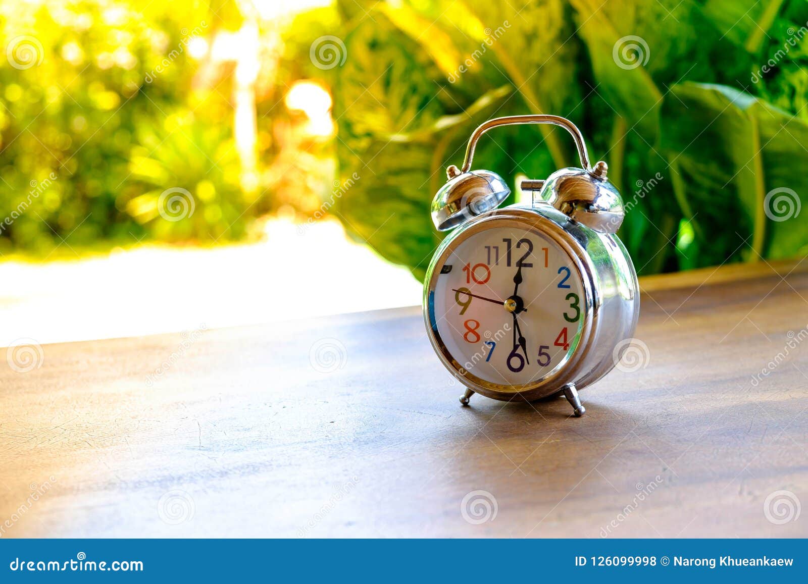 Alarm clock on wood table stock photo. Image of concept - 126099998
