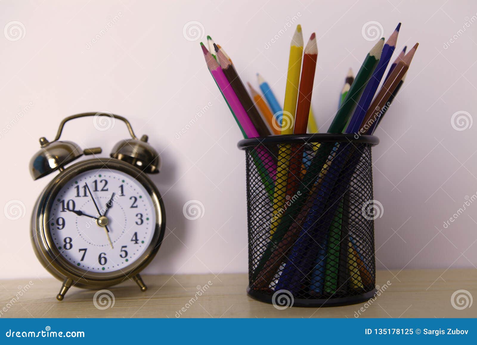 Alarm clock with pencils stock image. Image of school - 135178125