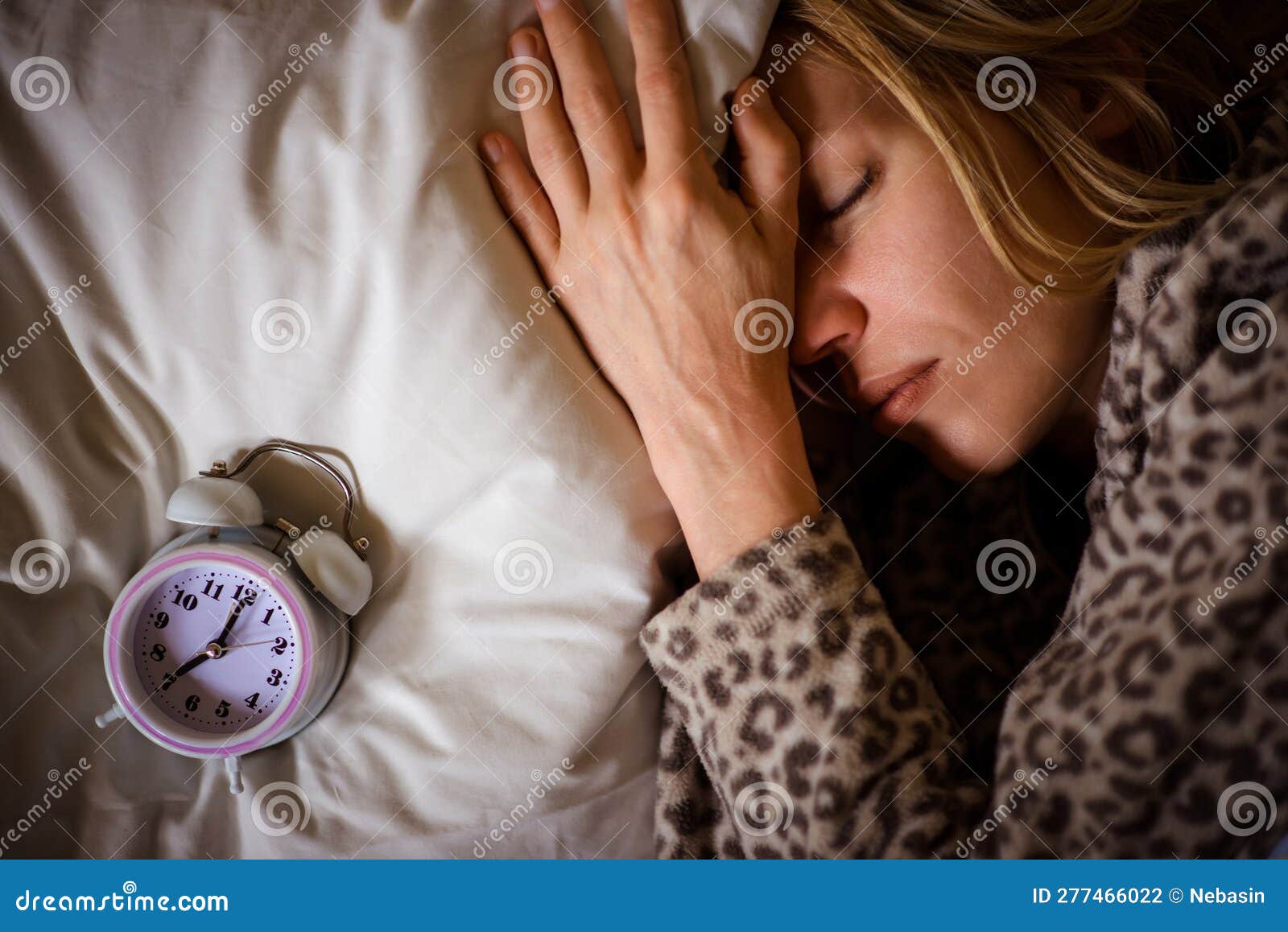 Alarm Clock on the Pillow and a Sleeping Woman. the Concept of Sleep ... Alarm Clock on the Pillow and a Sleeping Woman. the Concept of Sleep ...