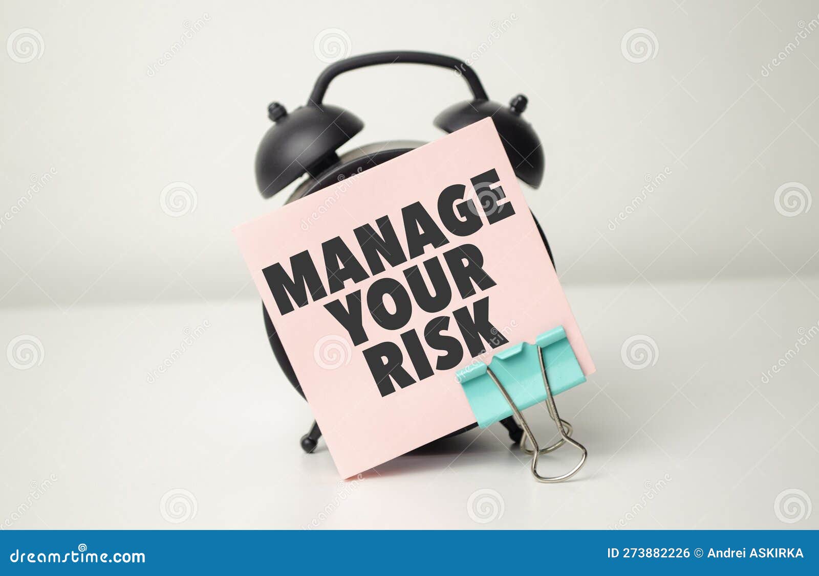 Alarm Clock with Pink Sticker with the Text Manage Your Risk Stock ...
