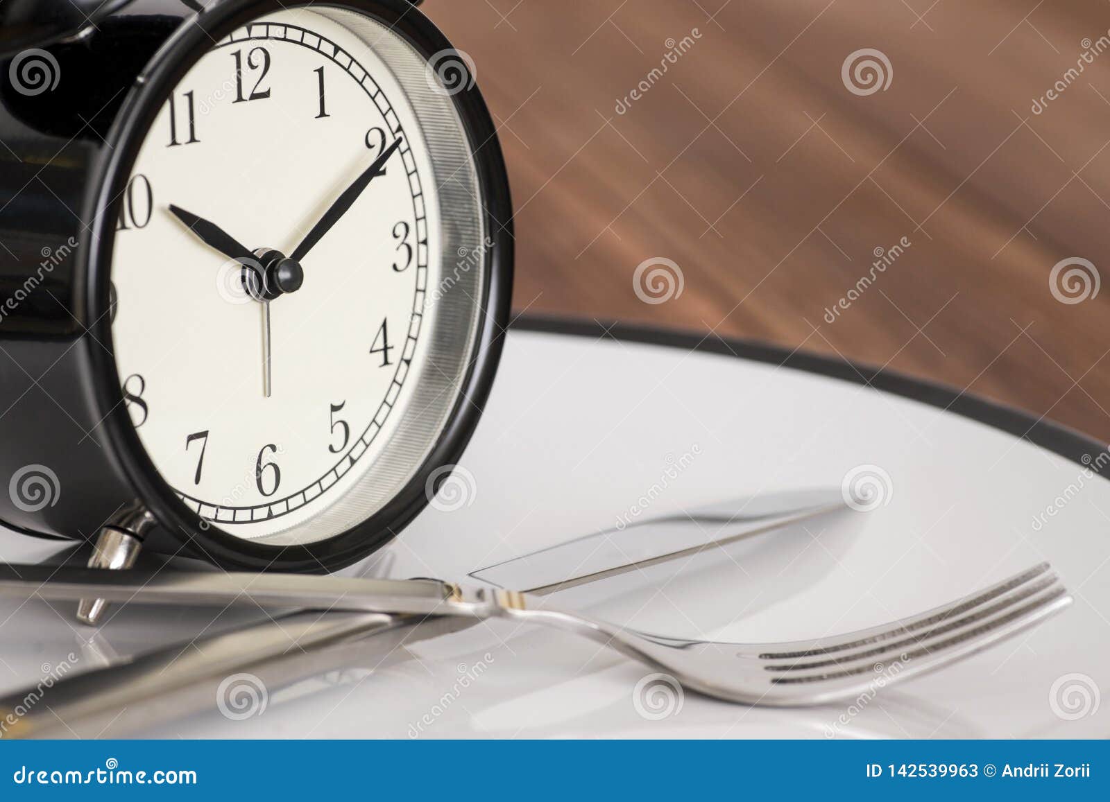 Alarm Clock on Plate with Knife and Fork on Wooden Background. Weight ... Alarm Clock on Plate with Knife and Fork on Wooden Background. Weight ...