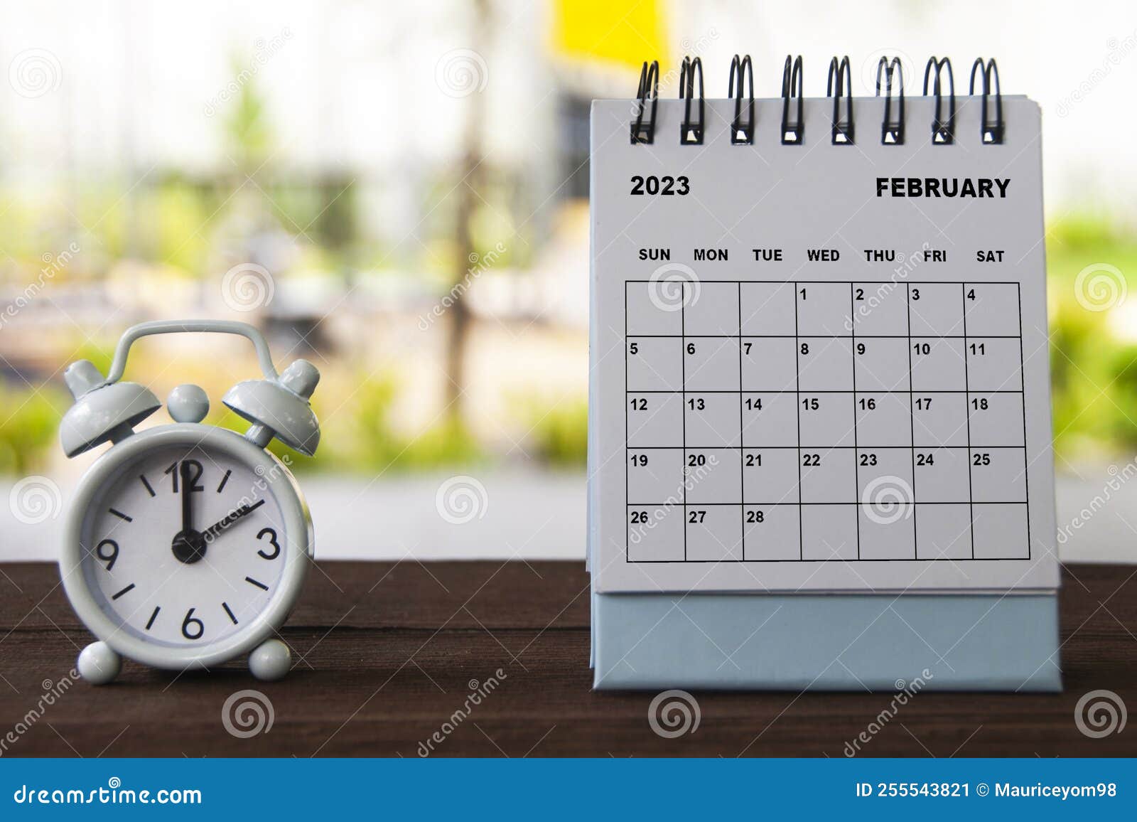 Alarm Clock Pointing at 2 O Clock with February 2023 on a Bench. Alarm ... Alarm Clock Pointing at 2 O Clock with February 2023 on a Bench. Alarm ...