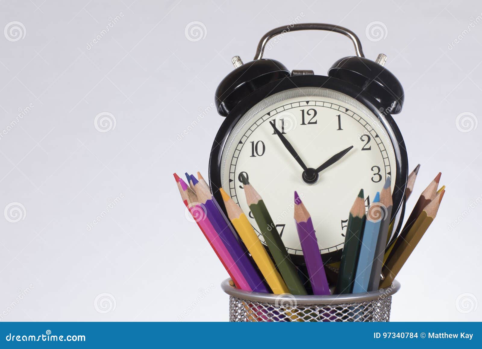 Alarm Clock Put in Container with Colored Pencils Stock Photo - Image ...