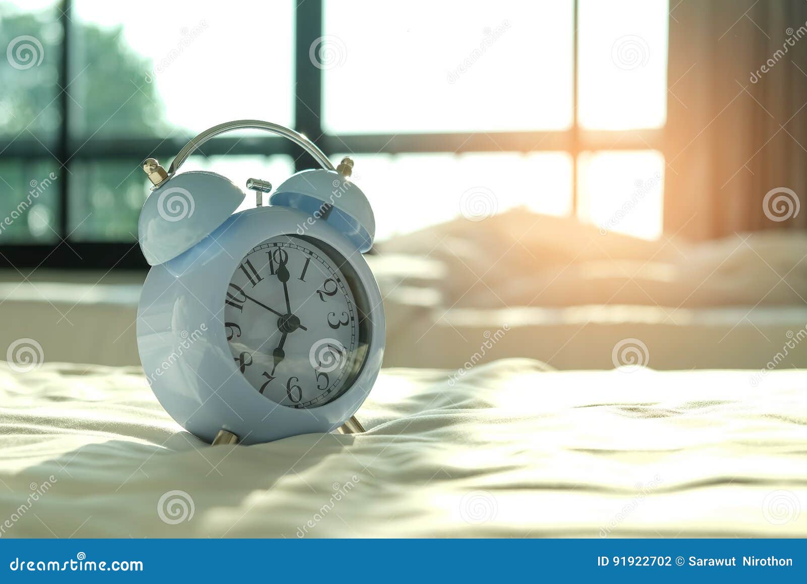 Alarm Clock Set at 7 O`clock on White Bed. Stock Photo - Image of wake ...