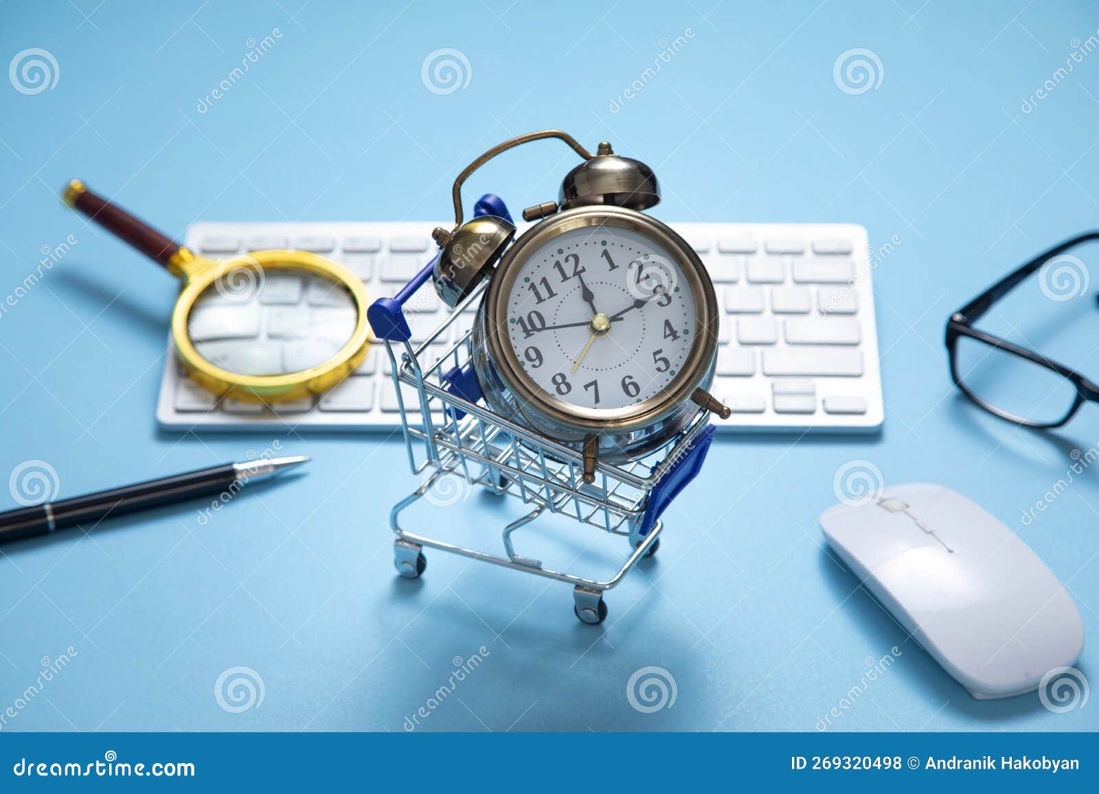 Alarm Clock, Shopping Cart on the Blue Background Stock Photo - Image ...