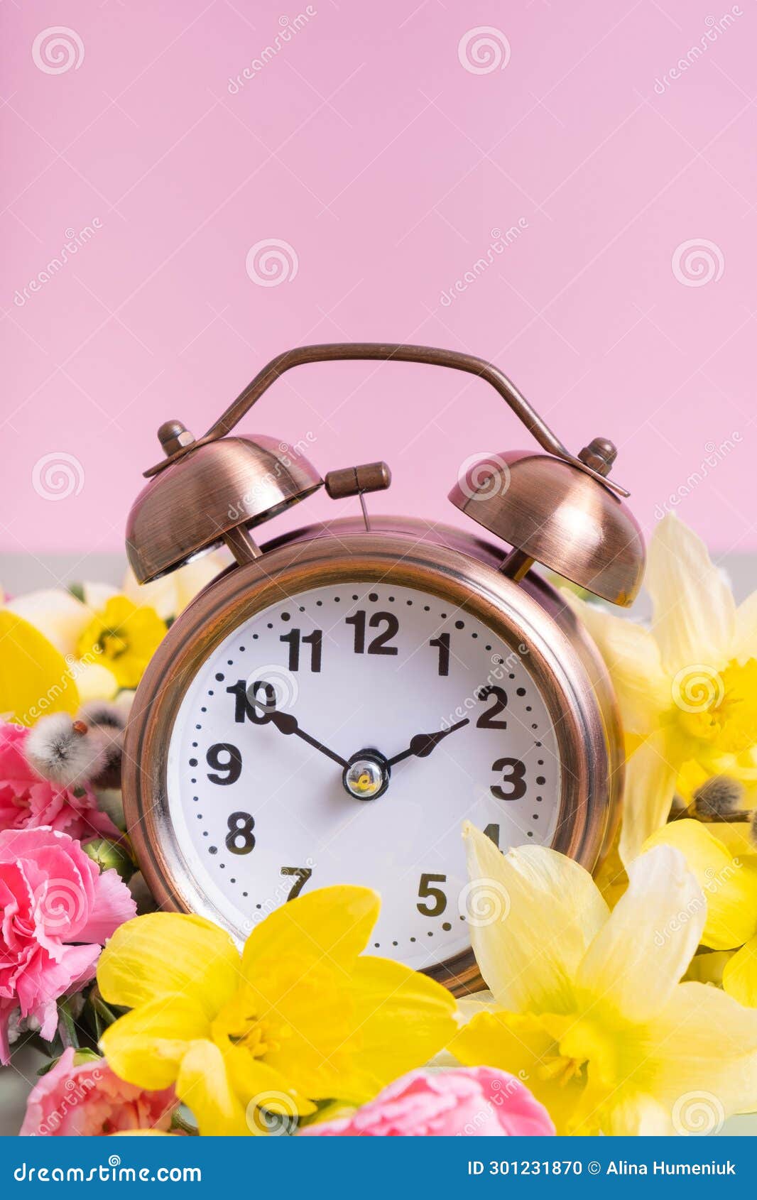 Alarm Clock with Spring Flowers. Spring Time, Daylight Savings Concept ...