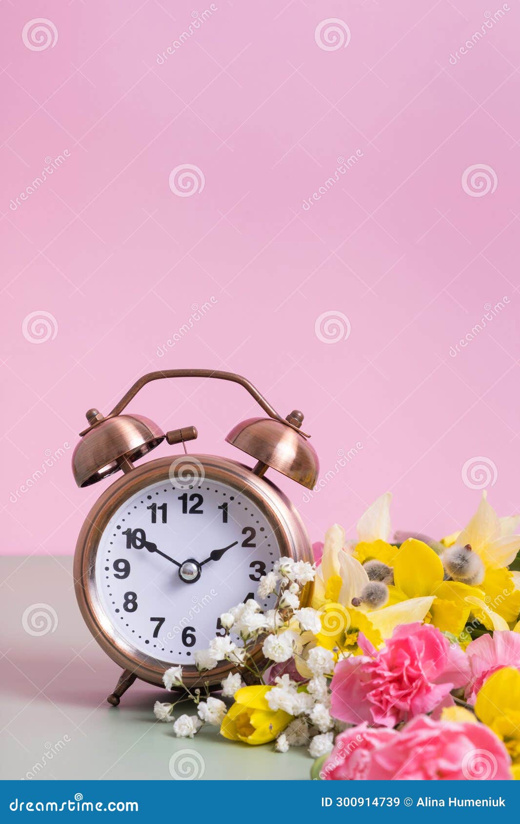 Alarm Clock with Spring Flowers. Spring Time, Daylight Savings Concept ...