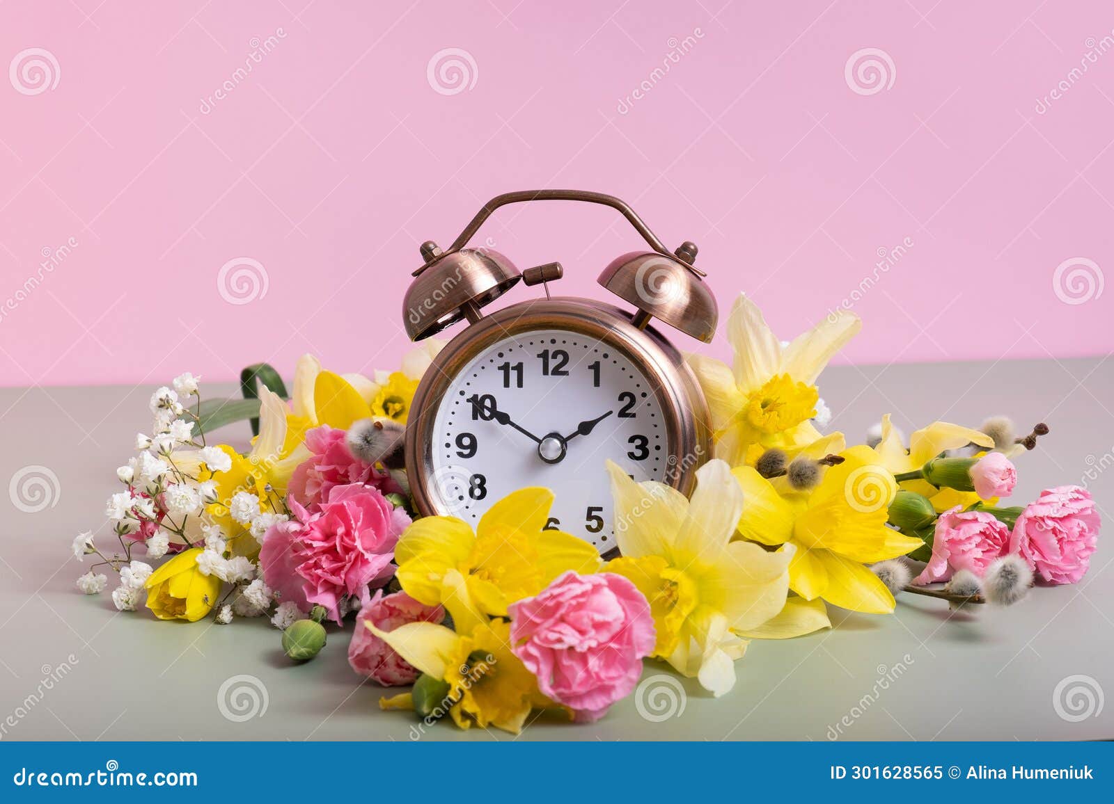 Alarm Clock with Spring Flowers. Spring Time, Daylight Savings Concept ...