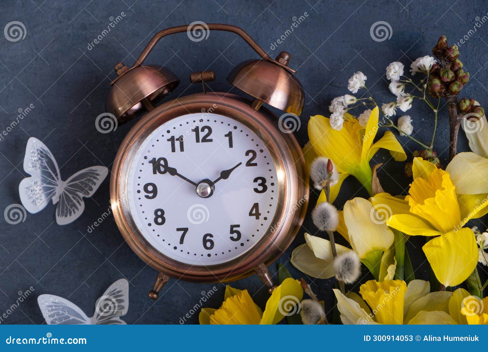 Alarm Clock with Spring Flowers. Spring Time, Daylight Savings Concept ...