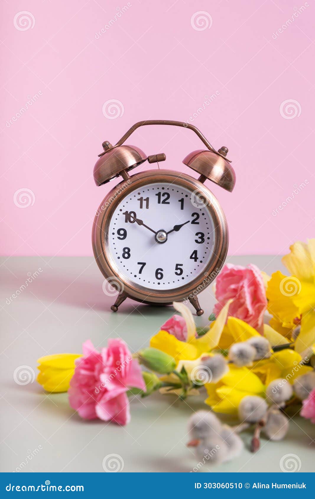 Alarm Clock with Spring Flowers. Spring Time, Daylight Savings Concept ...