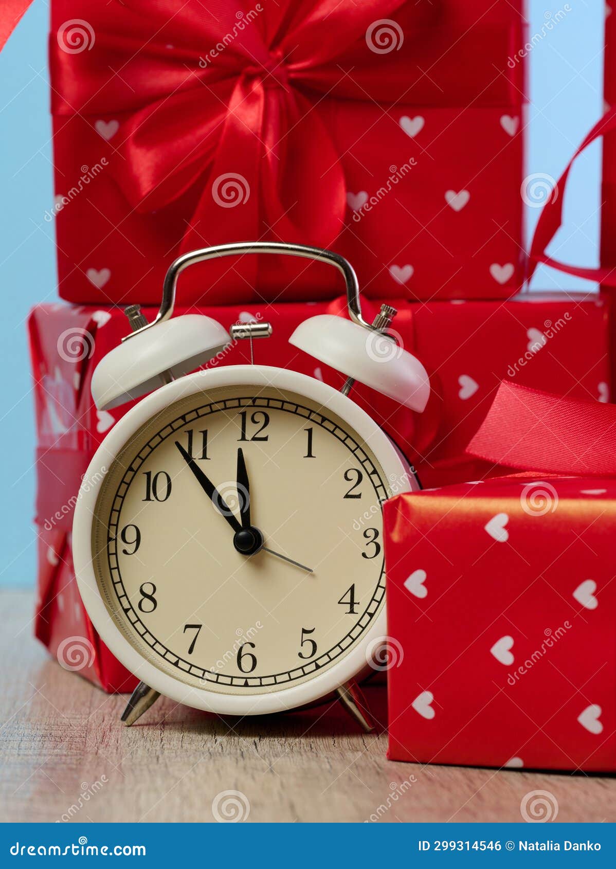 Alarm Clock and Stack of Red Gift Boxes on Blue Background Stock Photo ...