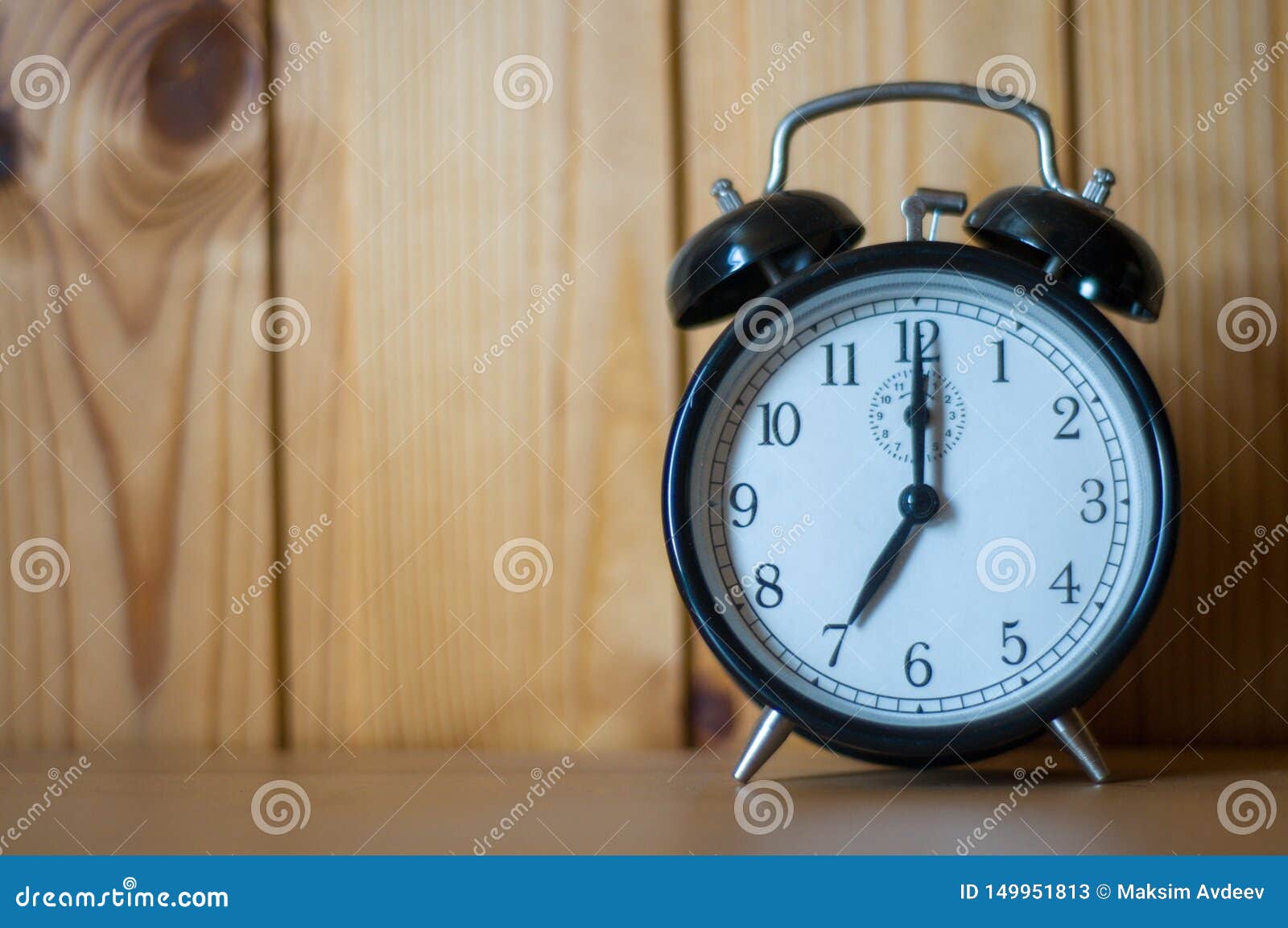 Alarm clock on table. Time stock image. Image of alarm - 149951813