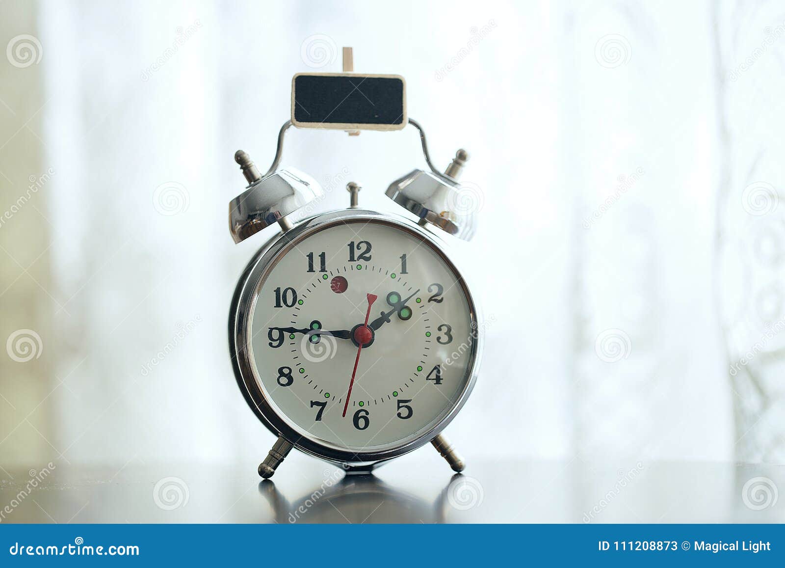 Alarm clock on the table stock image. Image of place - 111208873