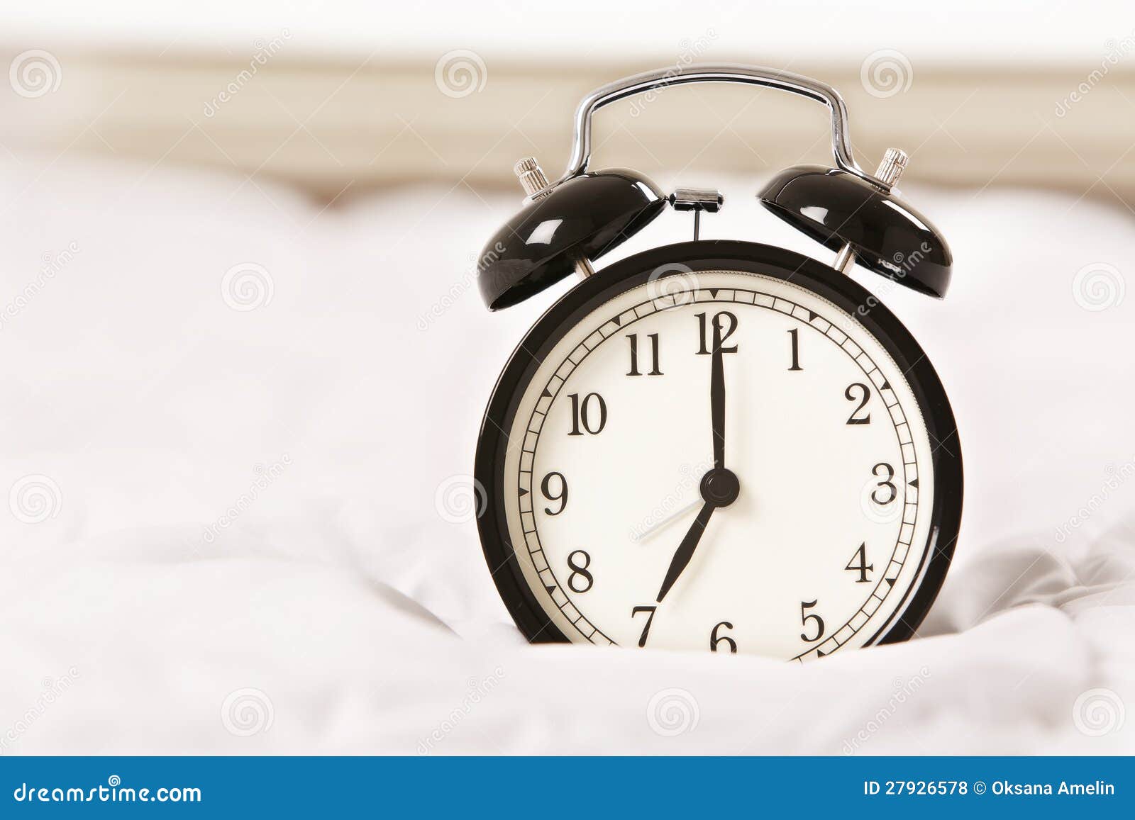 Alarm clock on white bed stock photo. Image of oclock - 27926578