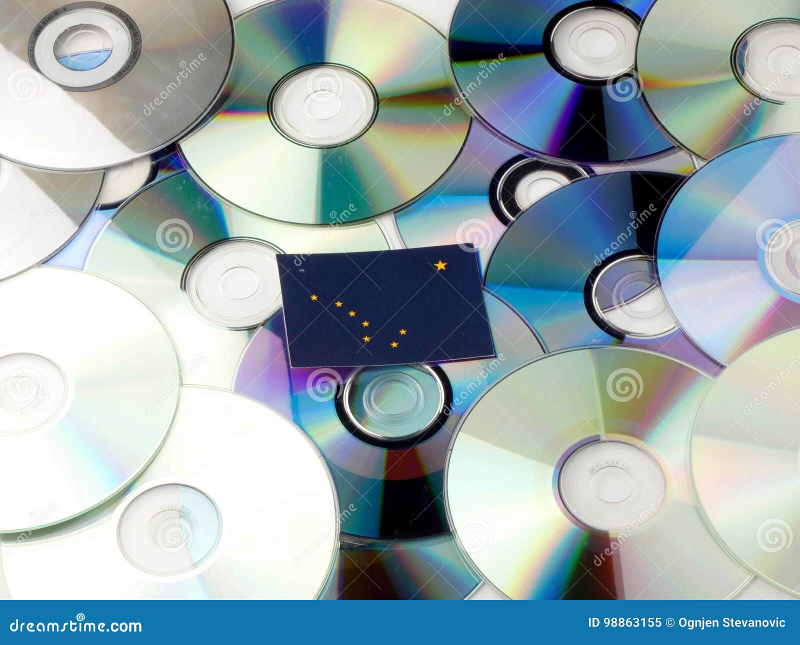 Alaska Flag on Top of CD and DVD Pile on White Stock Image - Image of ...
