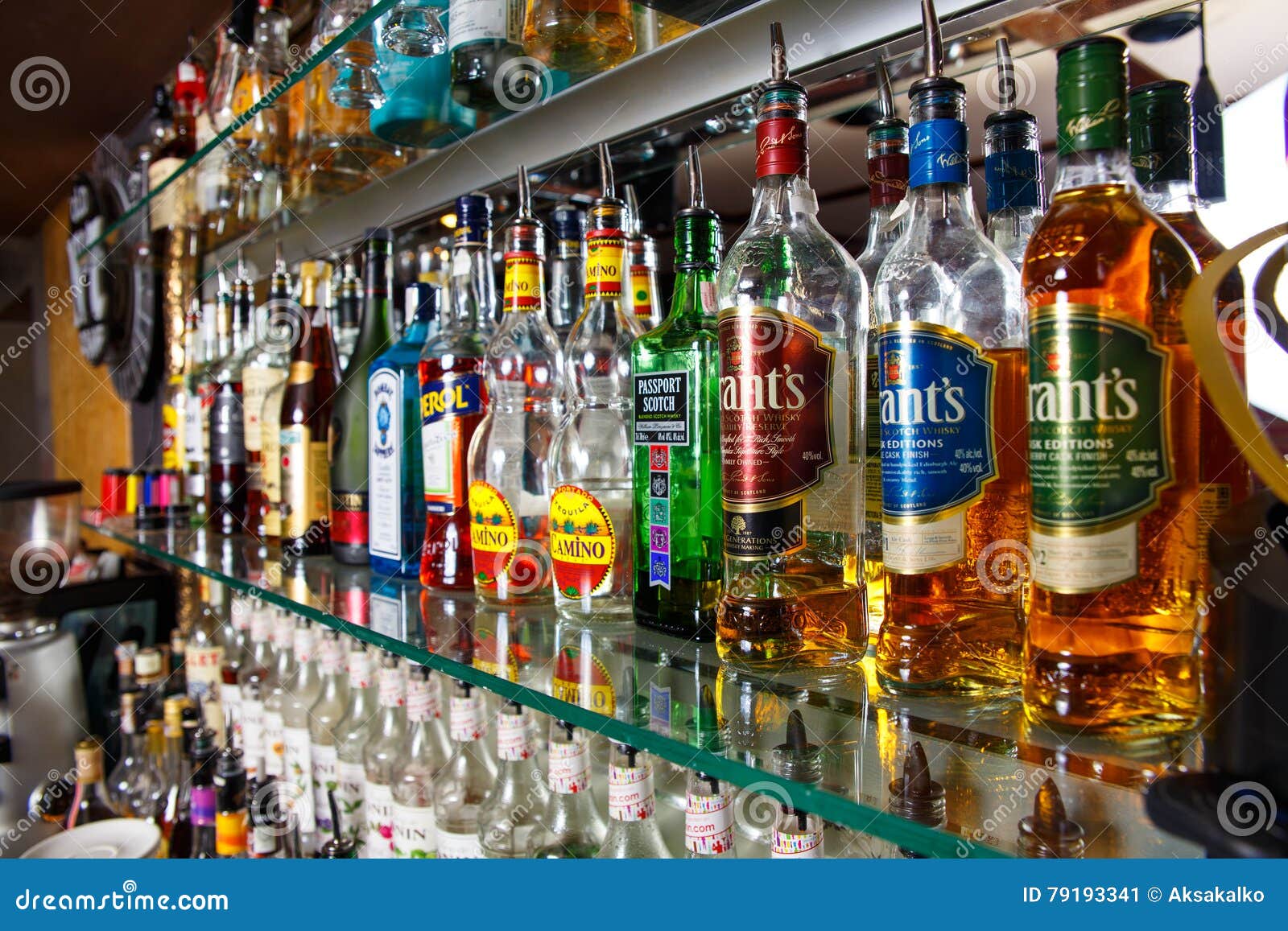 Alcohol bottles on a bar editorial photo. Image of curacao - 79193341