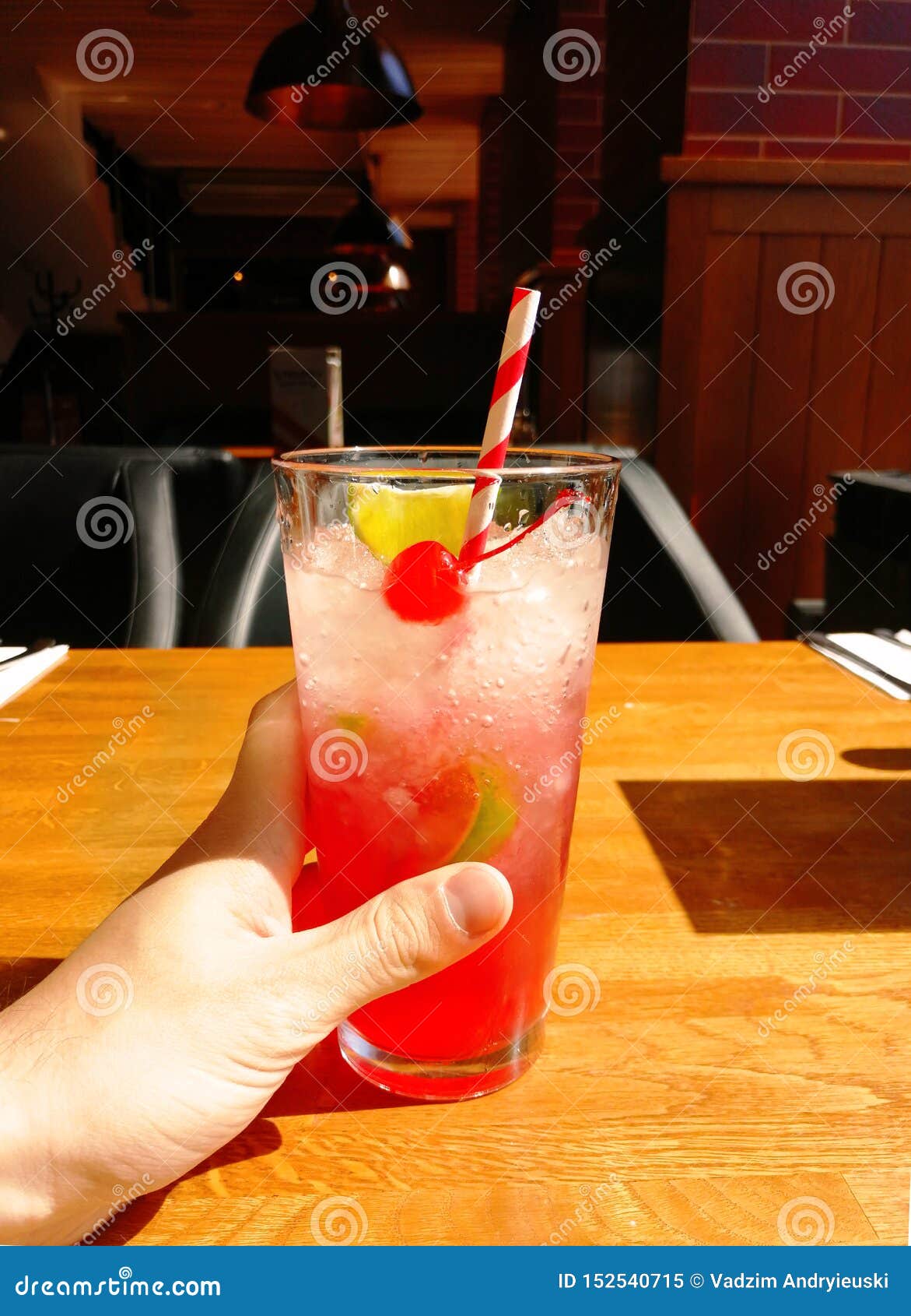 Alcohol Coctail Drink with Cherry, Lime and Lollipop Straw on the Table ...