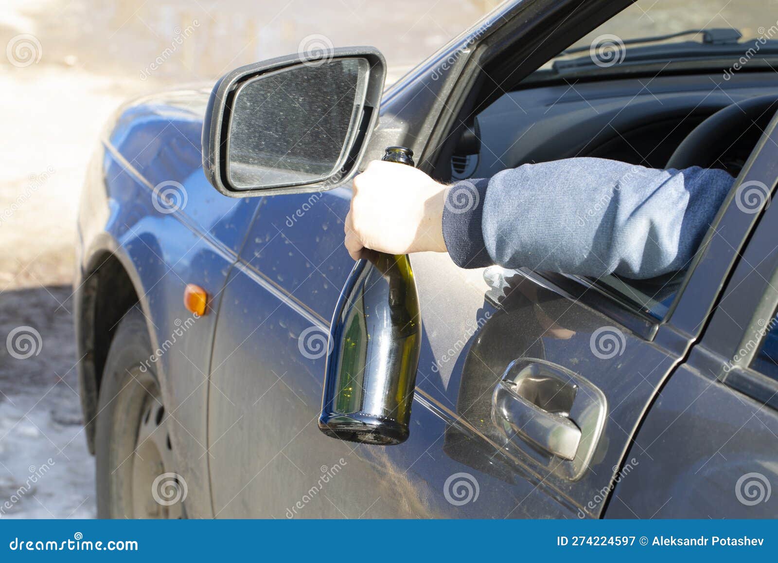 Alcohol while Driving a Car. a Driver Who Drinks Alcohol at the Wheel ...