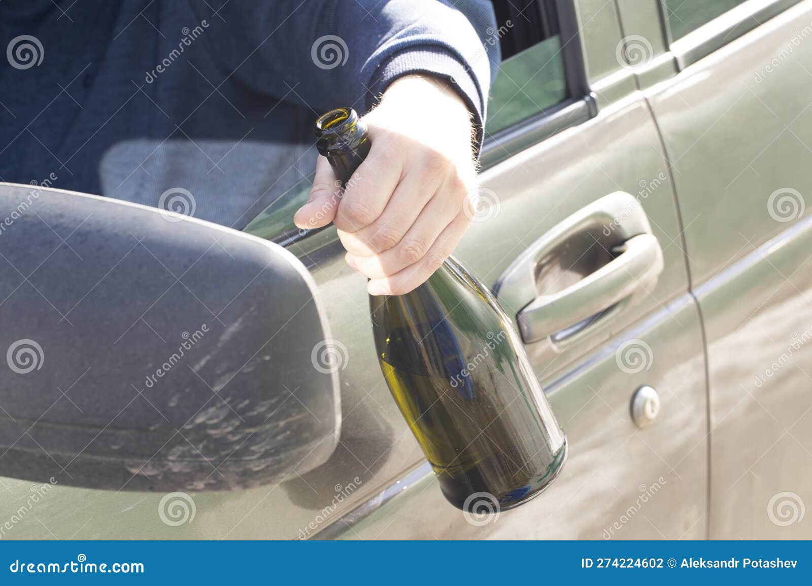 Alcohol while Driving a Car. a Driver Who Drinks Alcohol at the Wheel ...