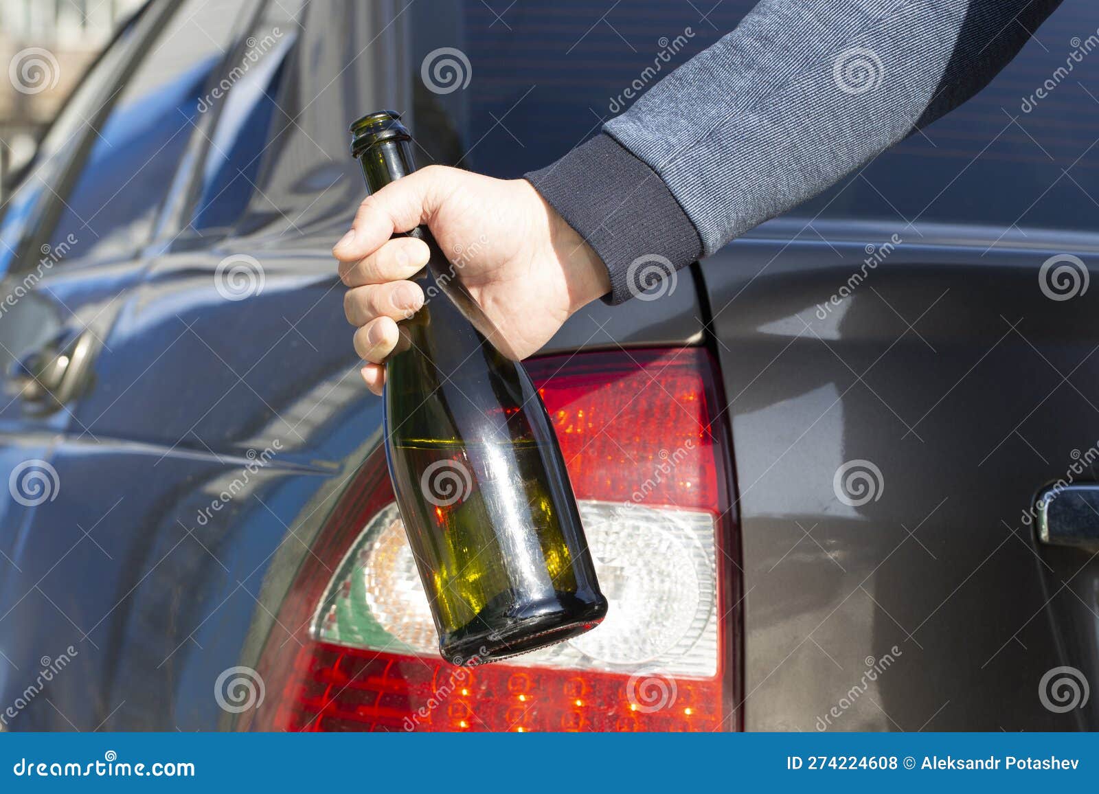 Alcohol while Driving a Car. a Driver Who Drinks Alcohol at the Wheel ...