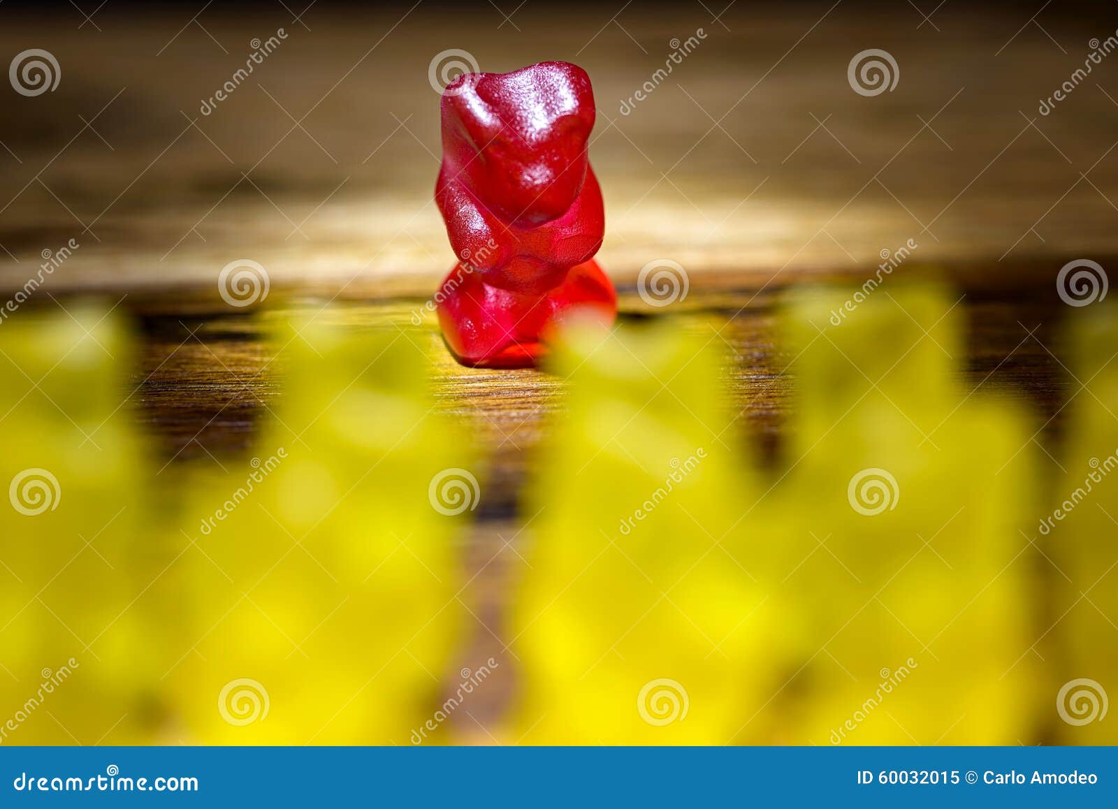 Unique Red Gummy Bear And Group Of Many Yellow Bears. Standing Out From ...