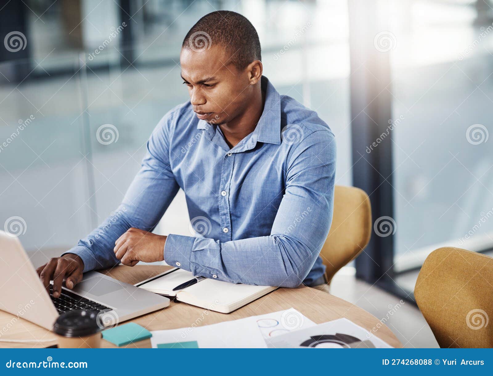 All in a Days Work. High Angle Shot of a Young Businessman Working in ...