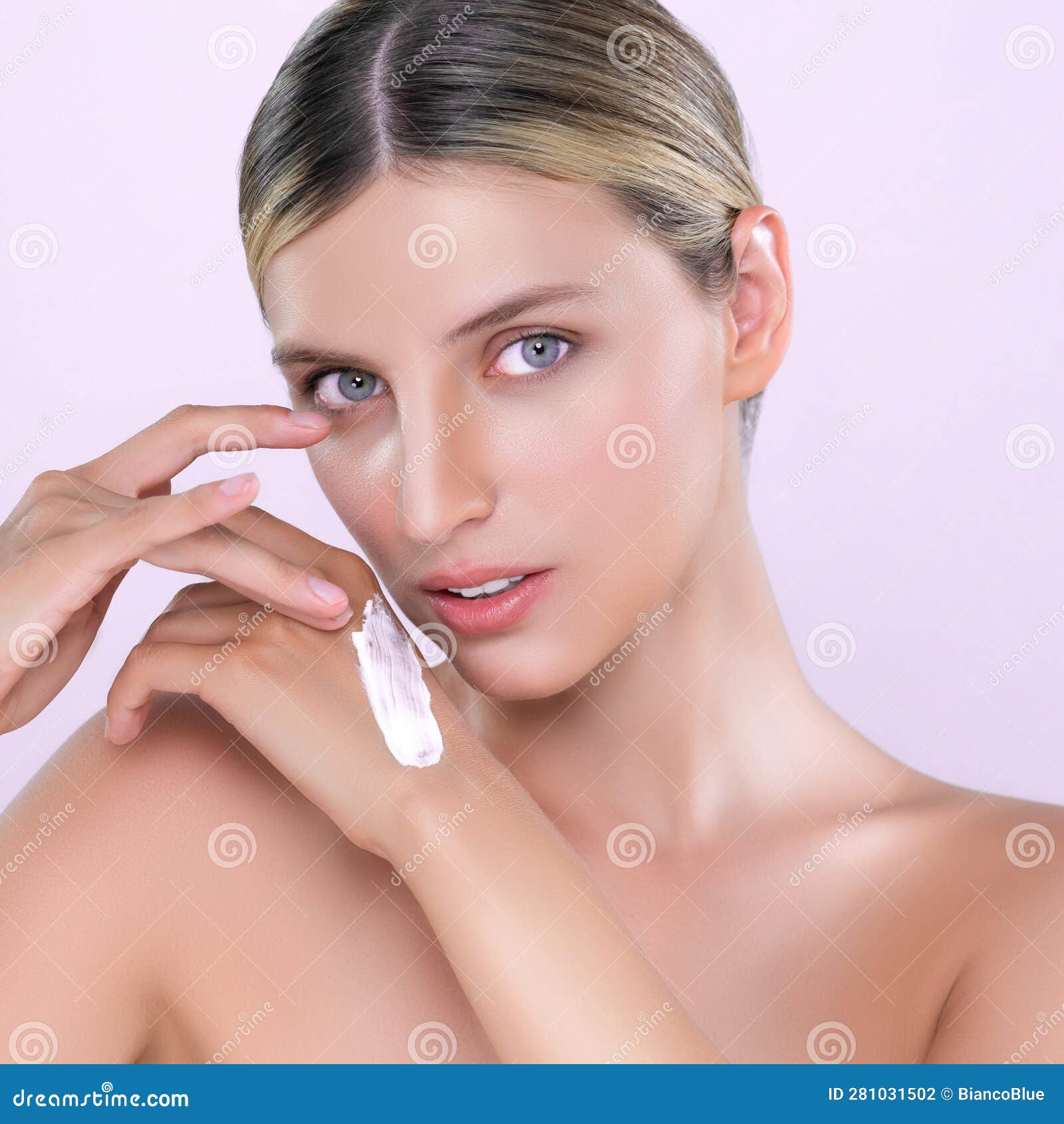 Alluring Beautiful Woman Applying Moisturizer Cream On Her Hand For