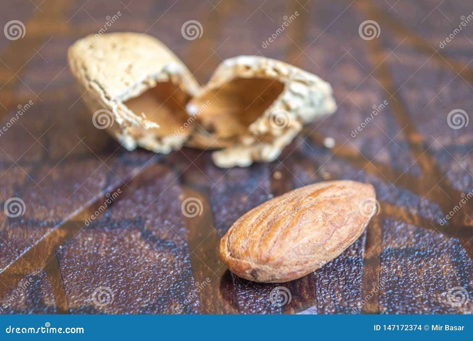 Almond Fruit Broken from the Brown Almond Shell on a Brown Wooden ...