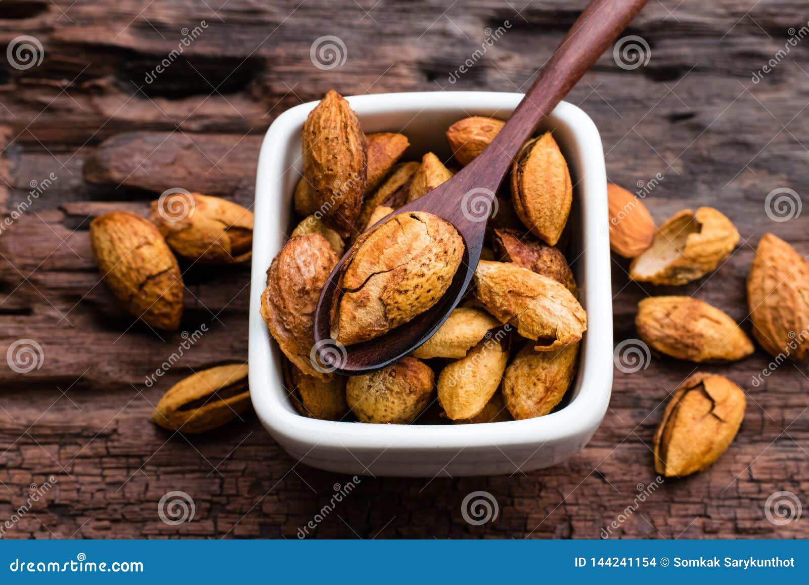 Almonds on old wood stock photo. Image of object, food - 144241154
