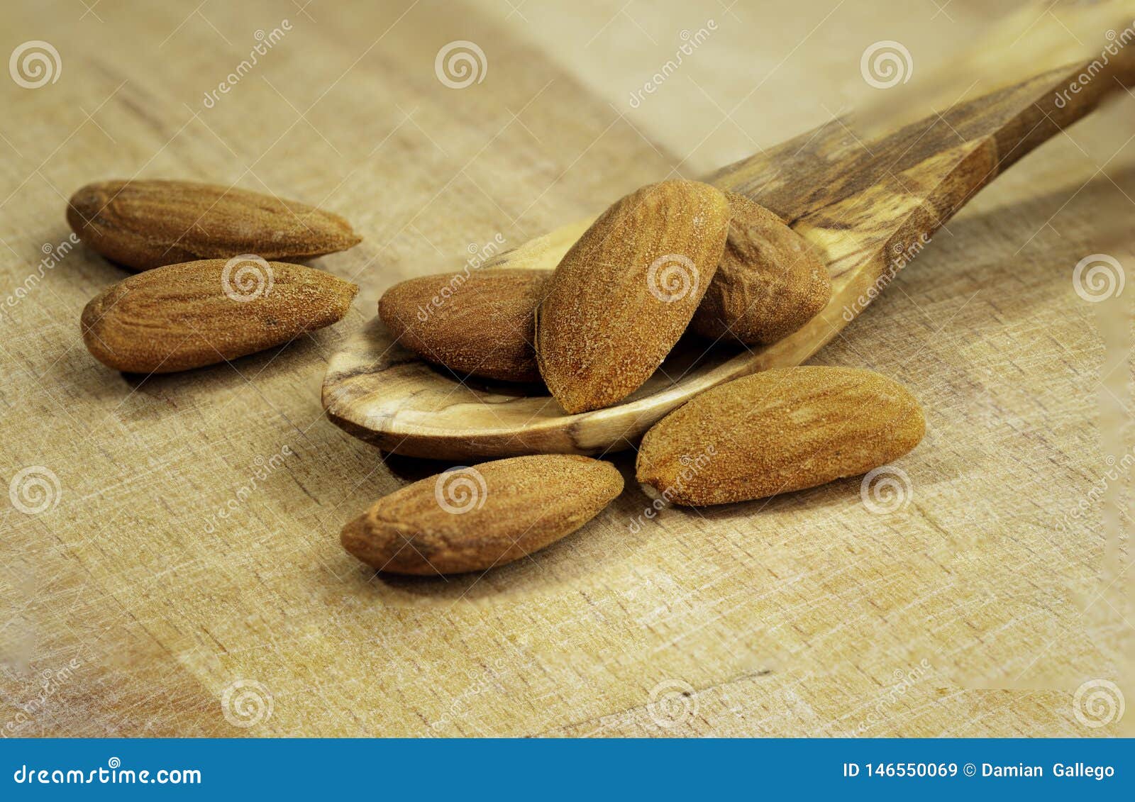 Almonds Pour from Wood Spoon on Wooden Table Stock Image - Image of ...