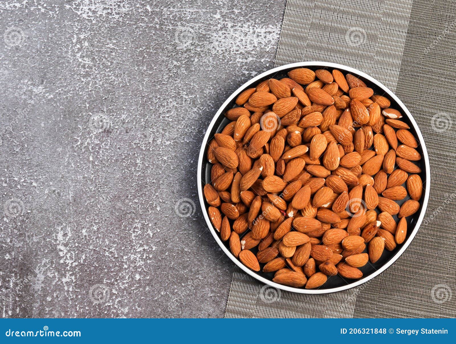 Almonds on a Round Plate on a Dark Background Stock Photo - Image of ...