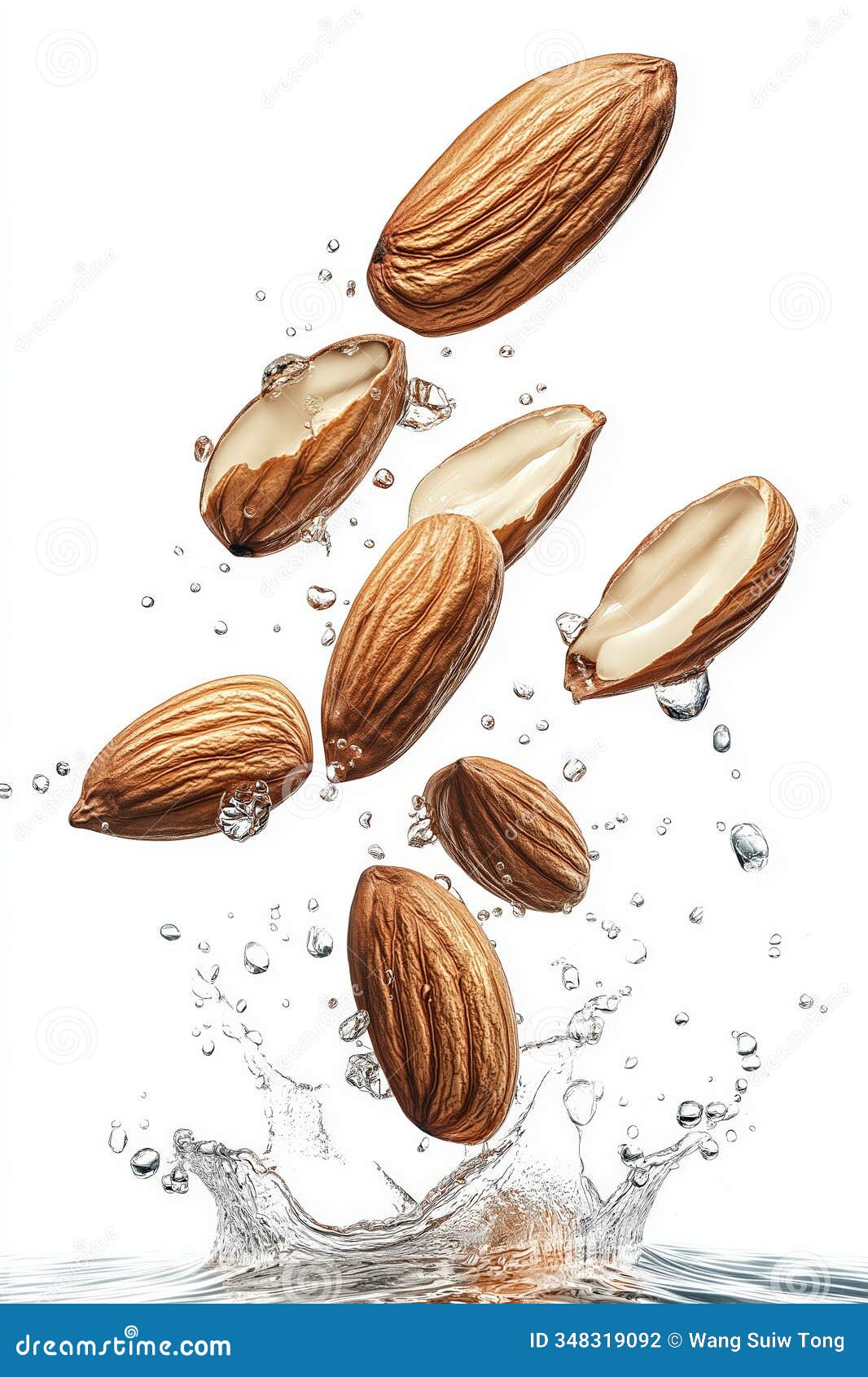 Almonds Splashing into Water with Bubbles on White Background Stock ...