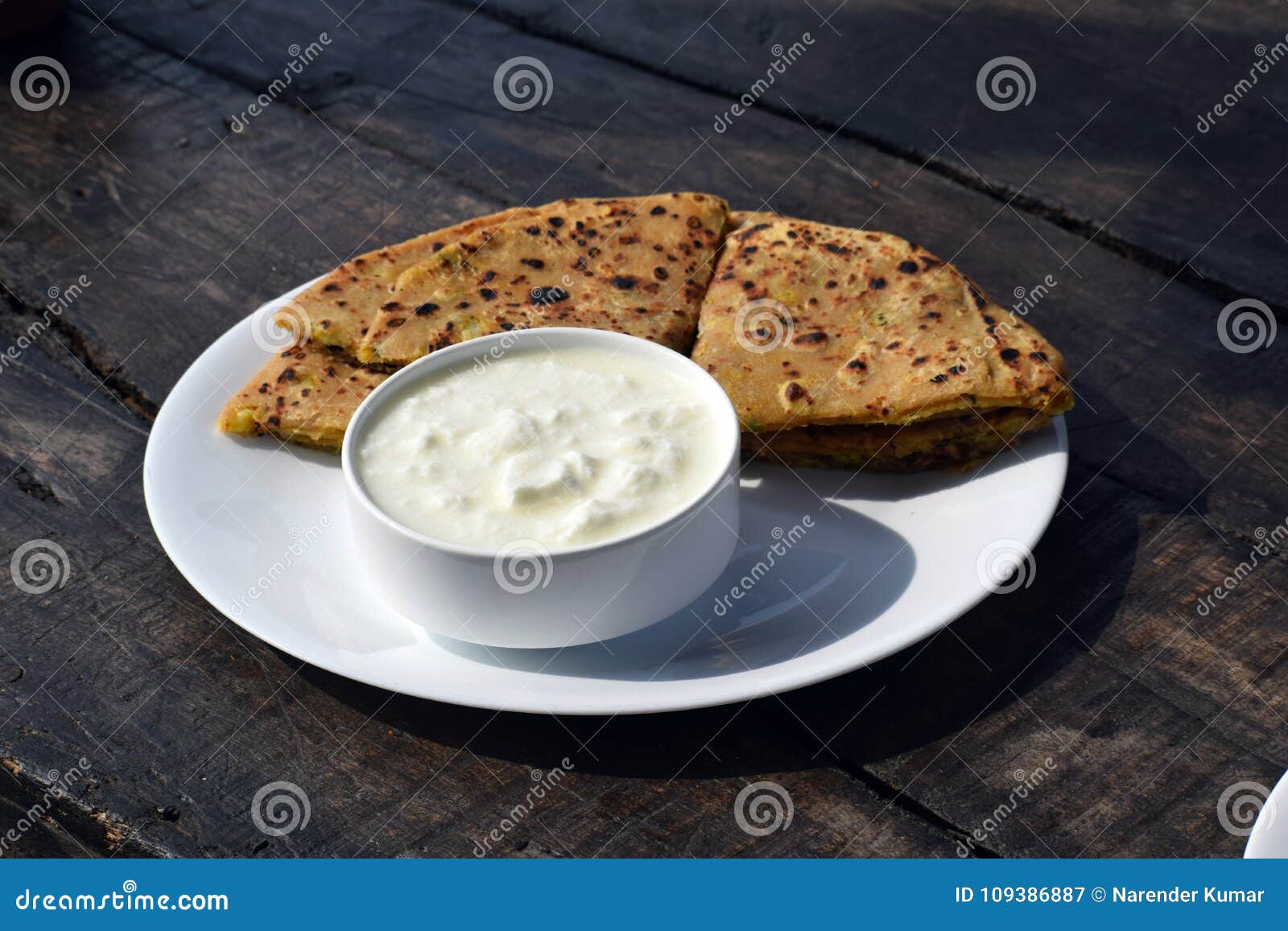 Aloo Paratha and Curd for Breakfast Placed on Wooden Board Stock Image ...