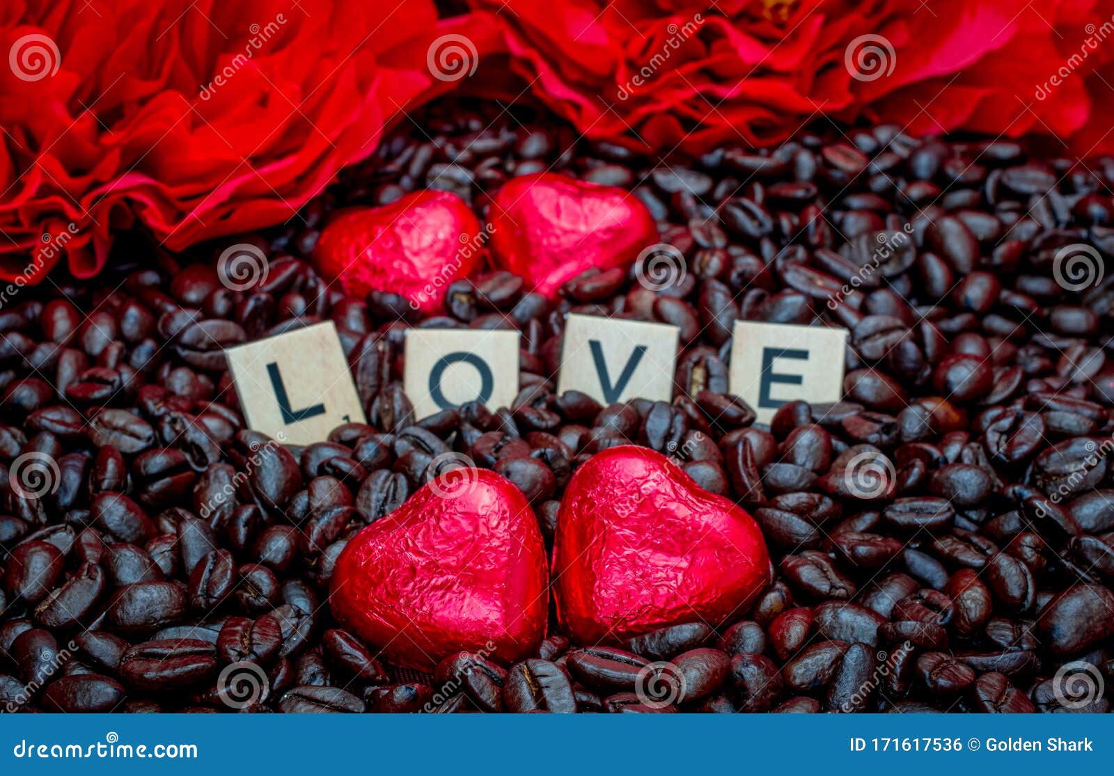 Red Macaroon On Rosted Coffee Beans Background With Red Flowers And