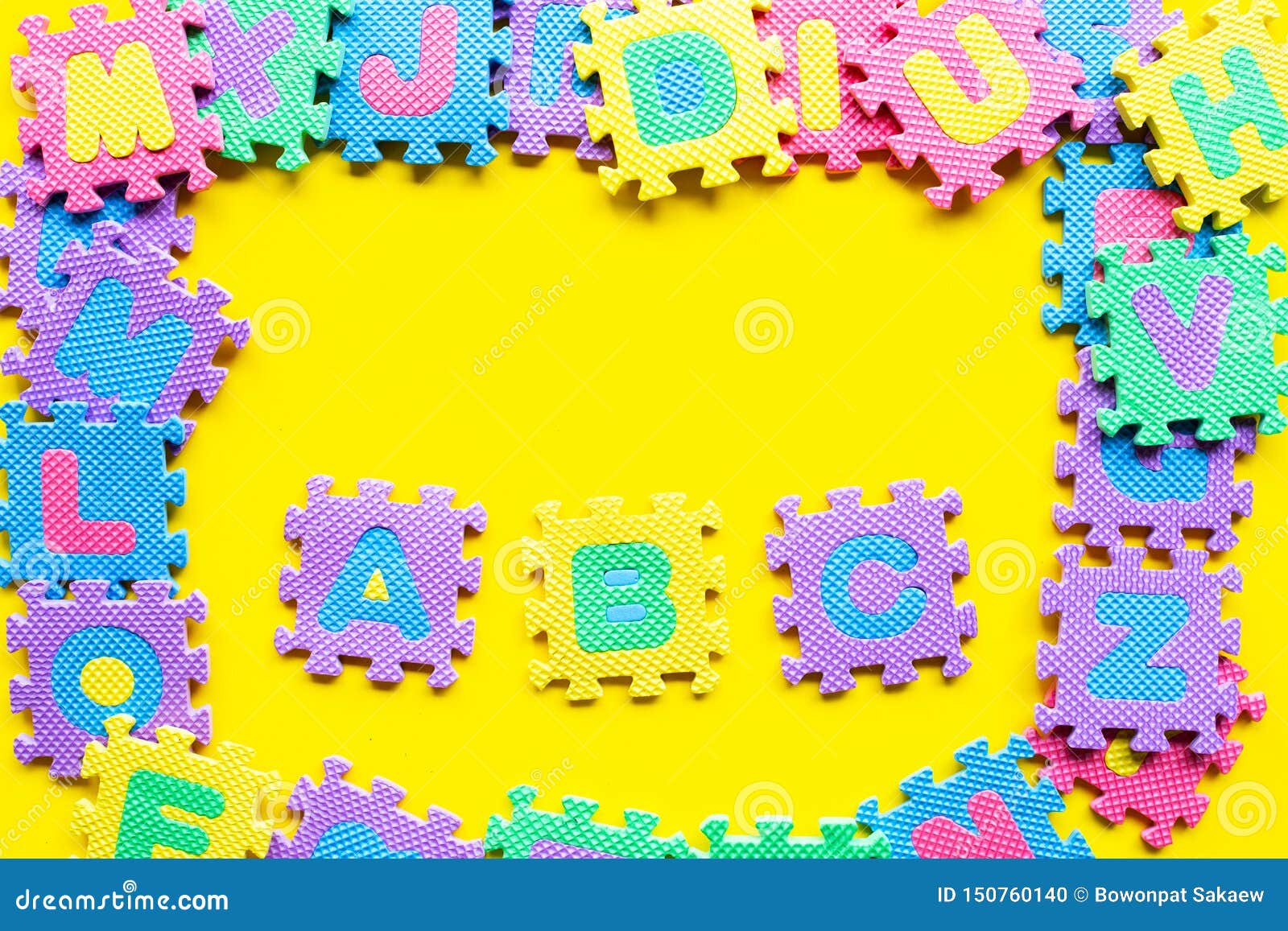 Alphabet Puzzle on Yellow Background Stock Photo - Image of foam ...
