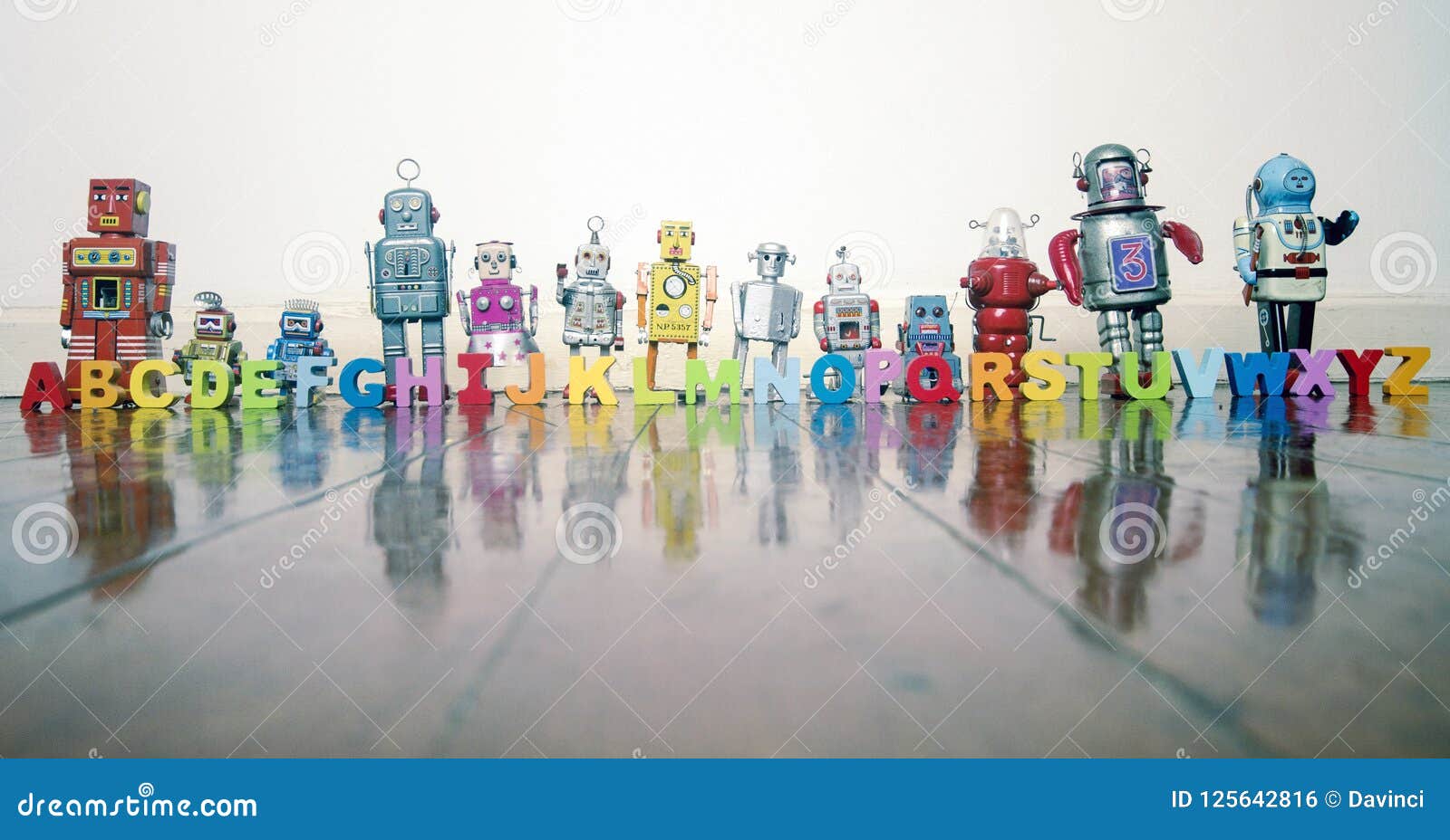Alphabet Robots Standing on a Wooden Floor Stock Photo - Image of ...