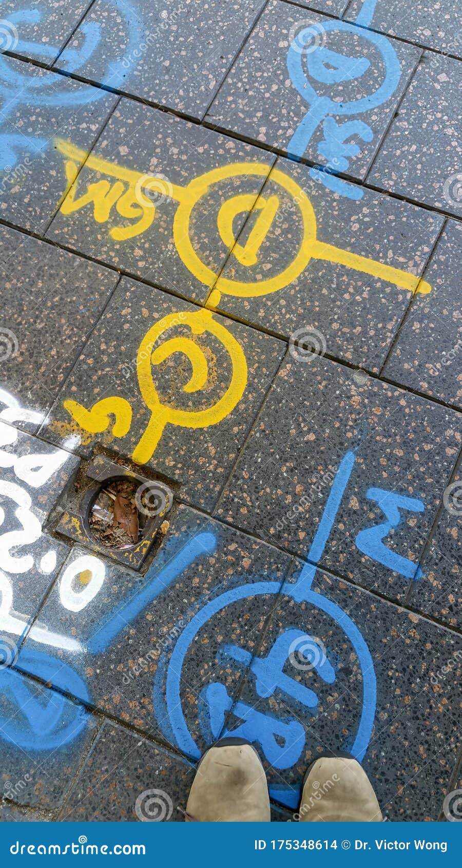 Alphanumeric and Symbol Spray Paint Markings on a Pedestrian Footpath ...