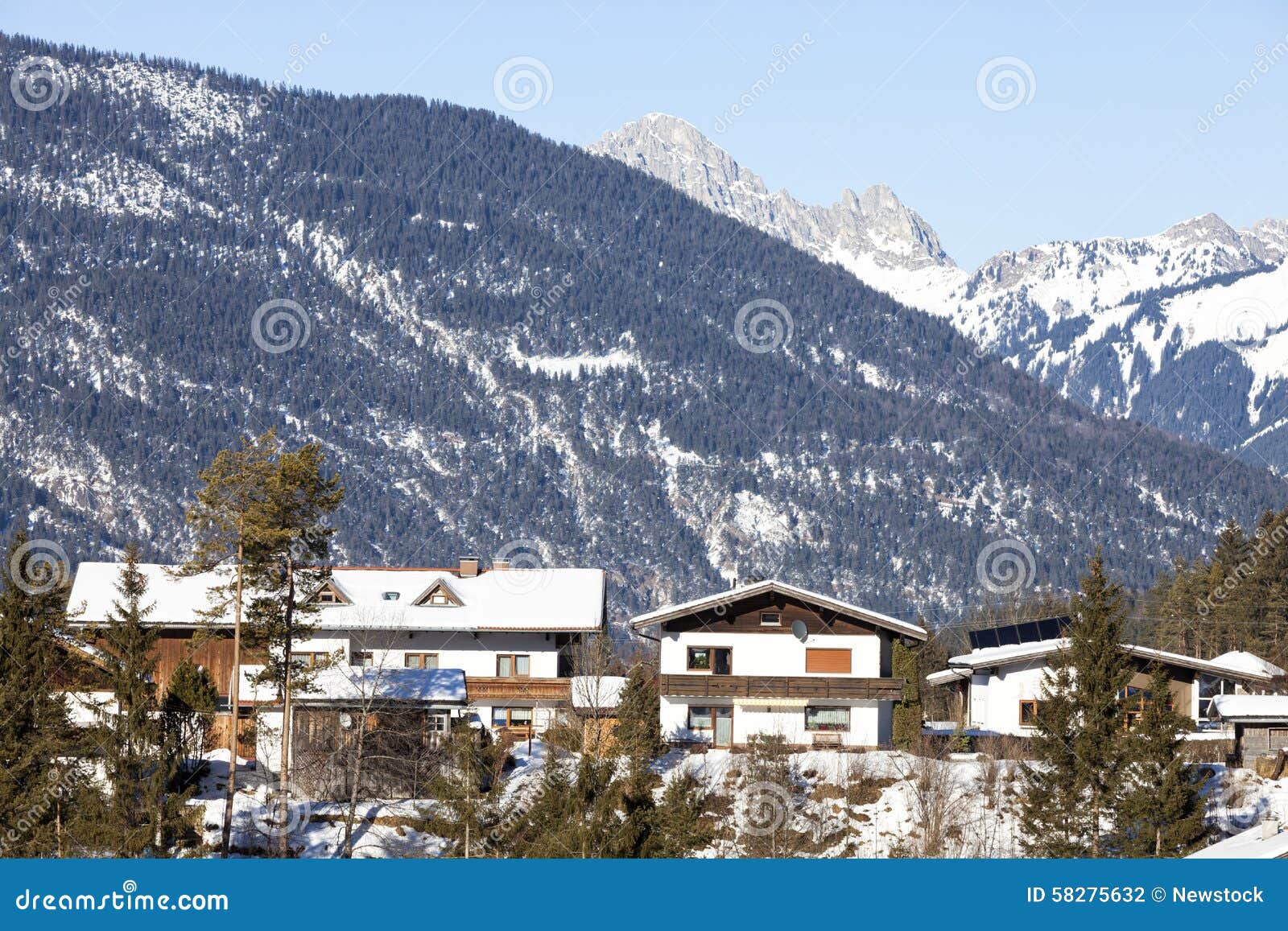 Alpine village in the snow stock photo. Image of outdoors - 58275632
